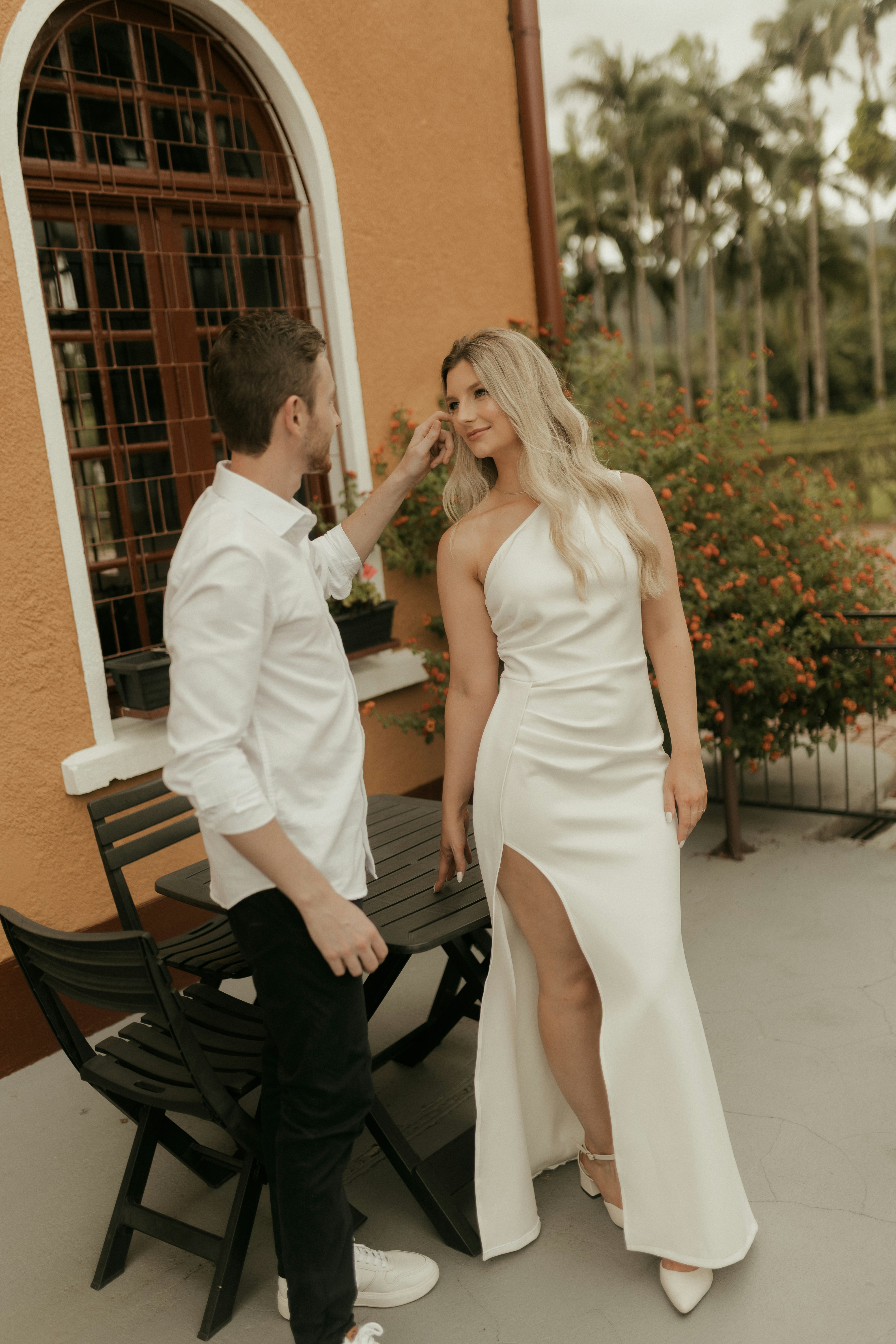 Ivory Silk: a candid moment between a couple on a sunlit terrace