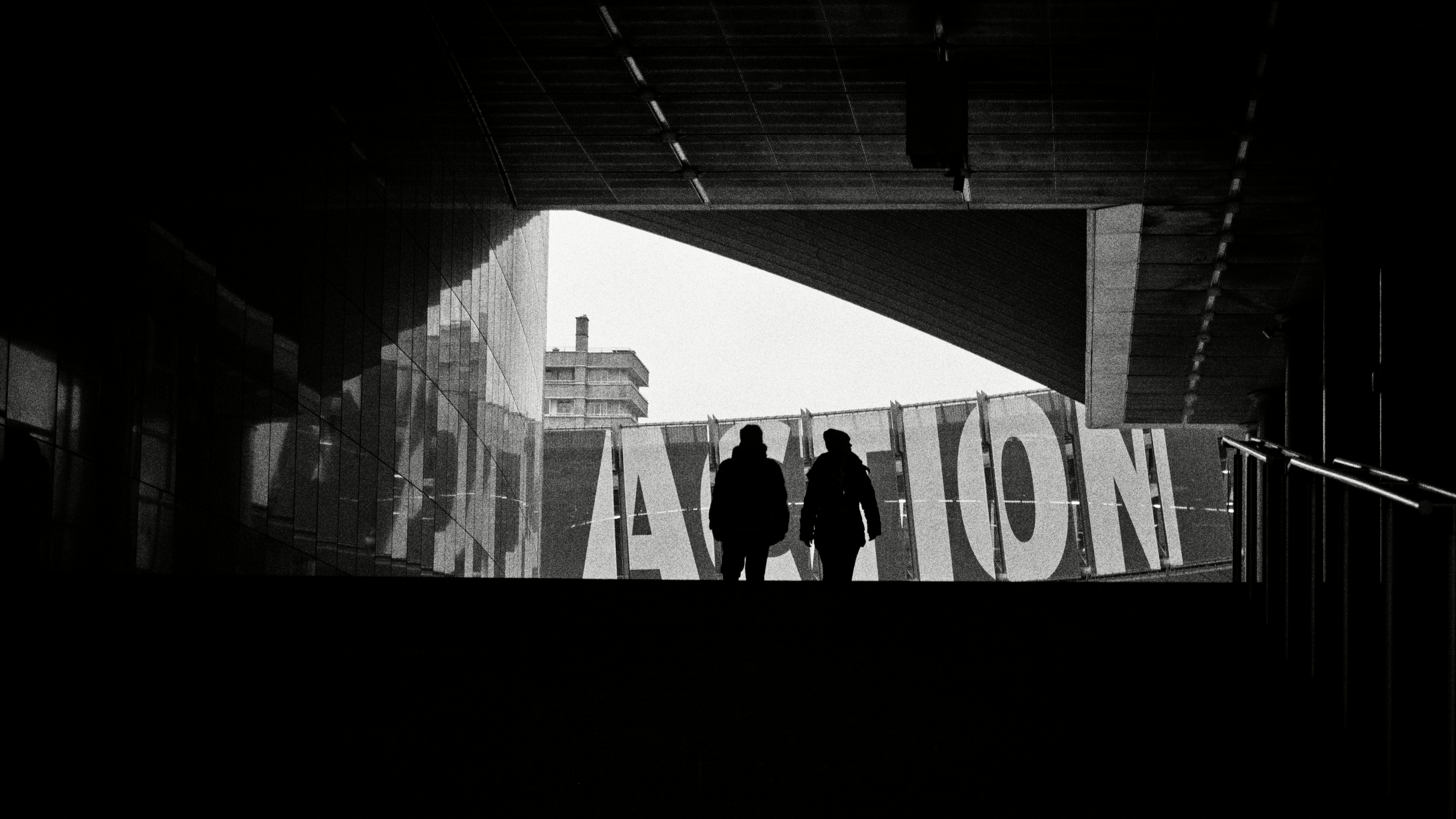 Shadowed silhouettes at the tunnel’s threshold