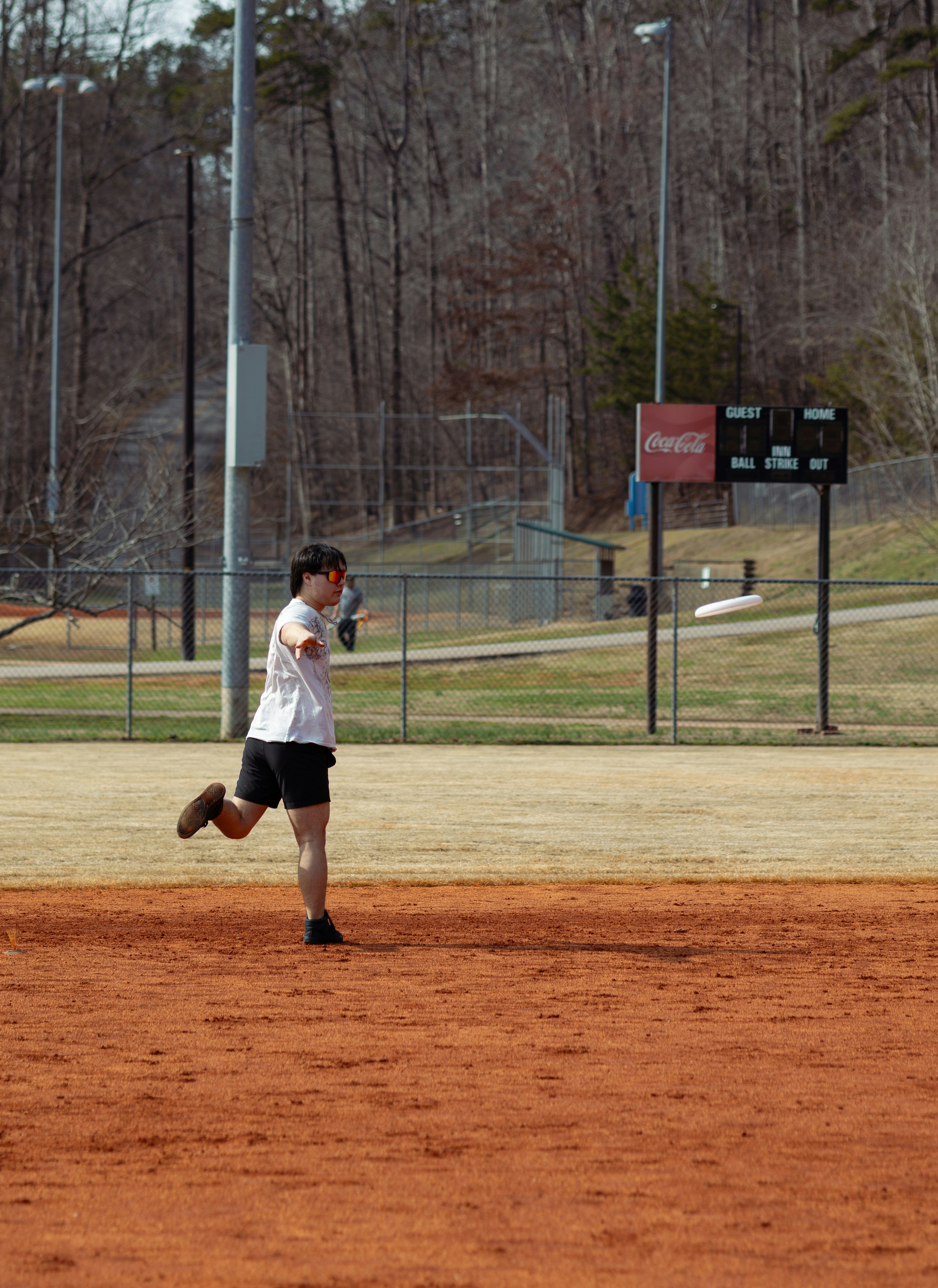 Youthful Pitcher in Motion on a Clay Infield