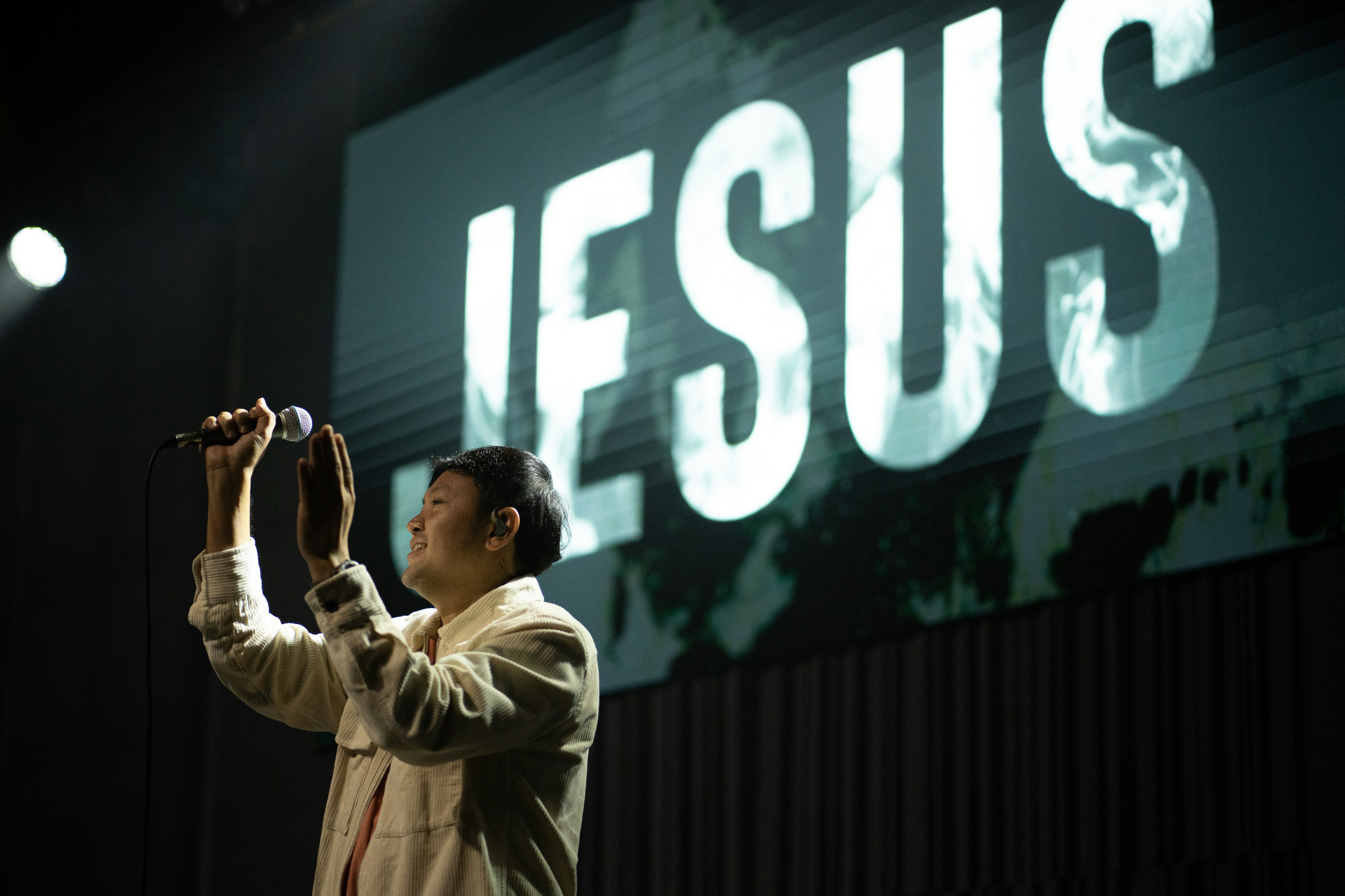 Stage Lights and Sermon: A Speaker Under the JESUS Banner