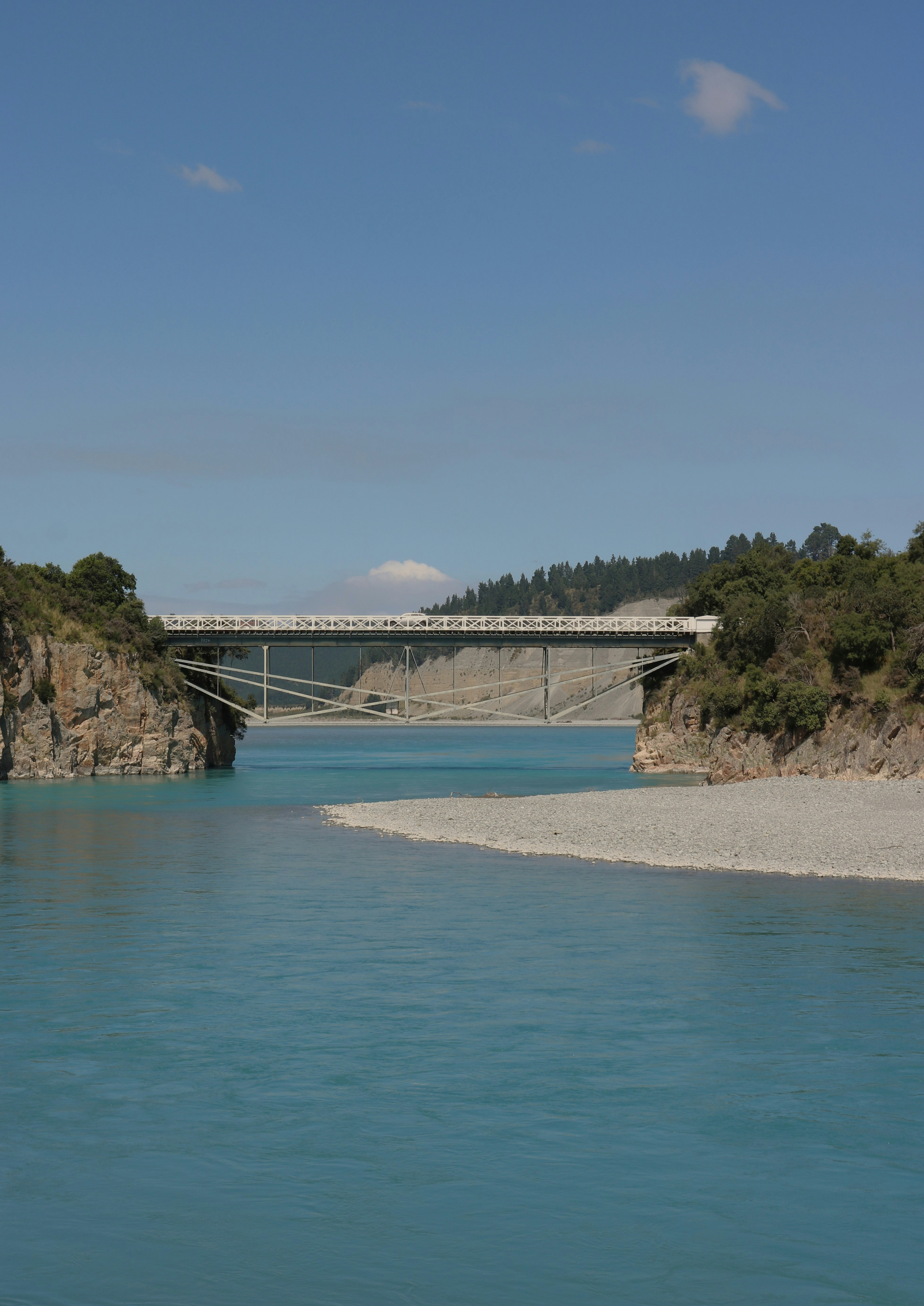 Azure Channel: Cliffside Bridge Framing a Quiet Passage