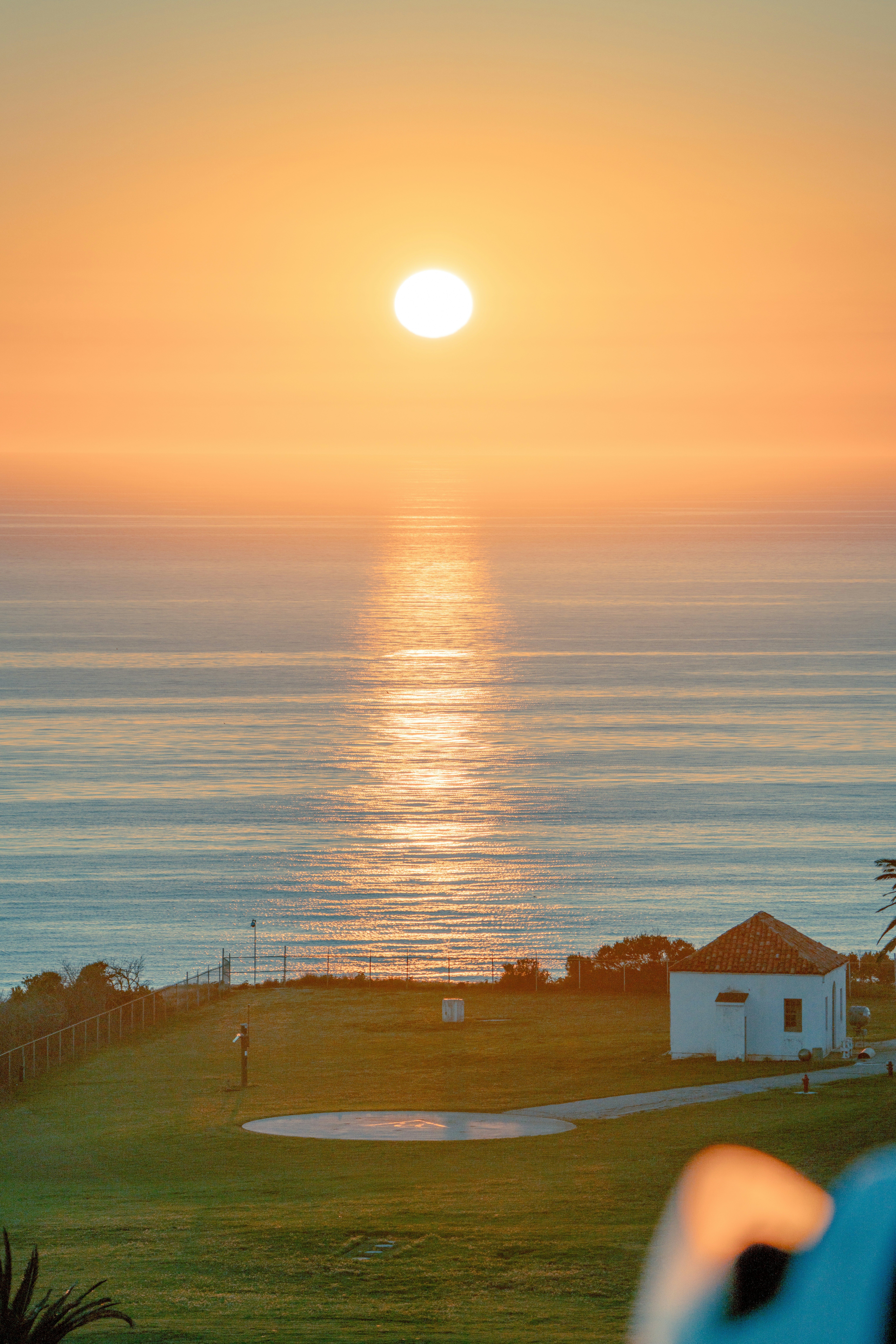 Sunlit Horizon: Calm Sea, Quiet Clifftop Scene