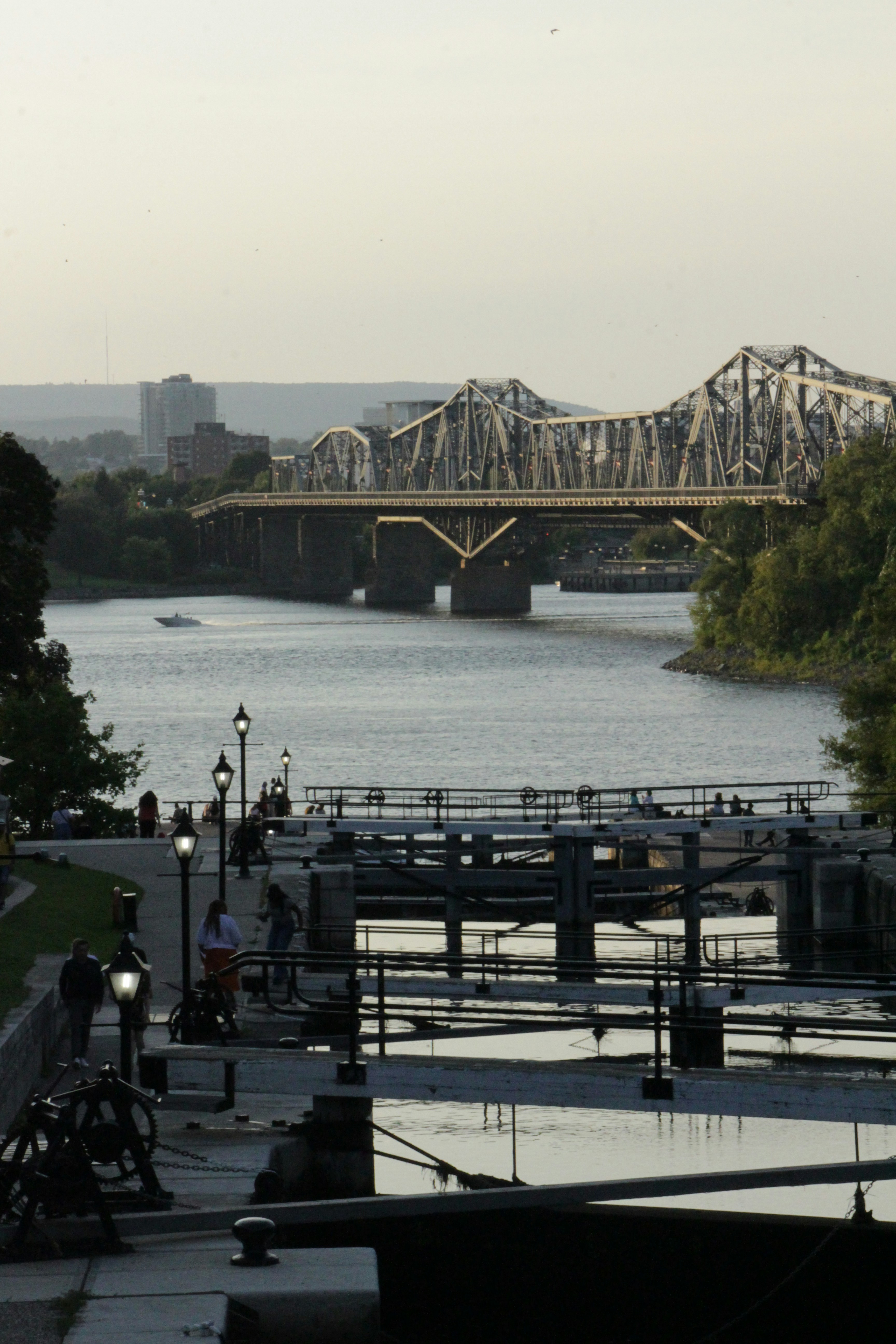 Bridge over calm river: a quiet riverside scene with a distant steel span