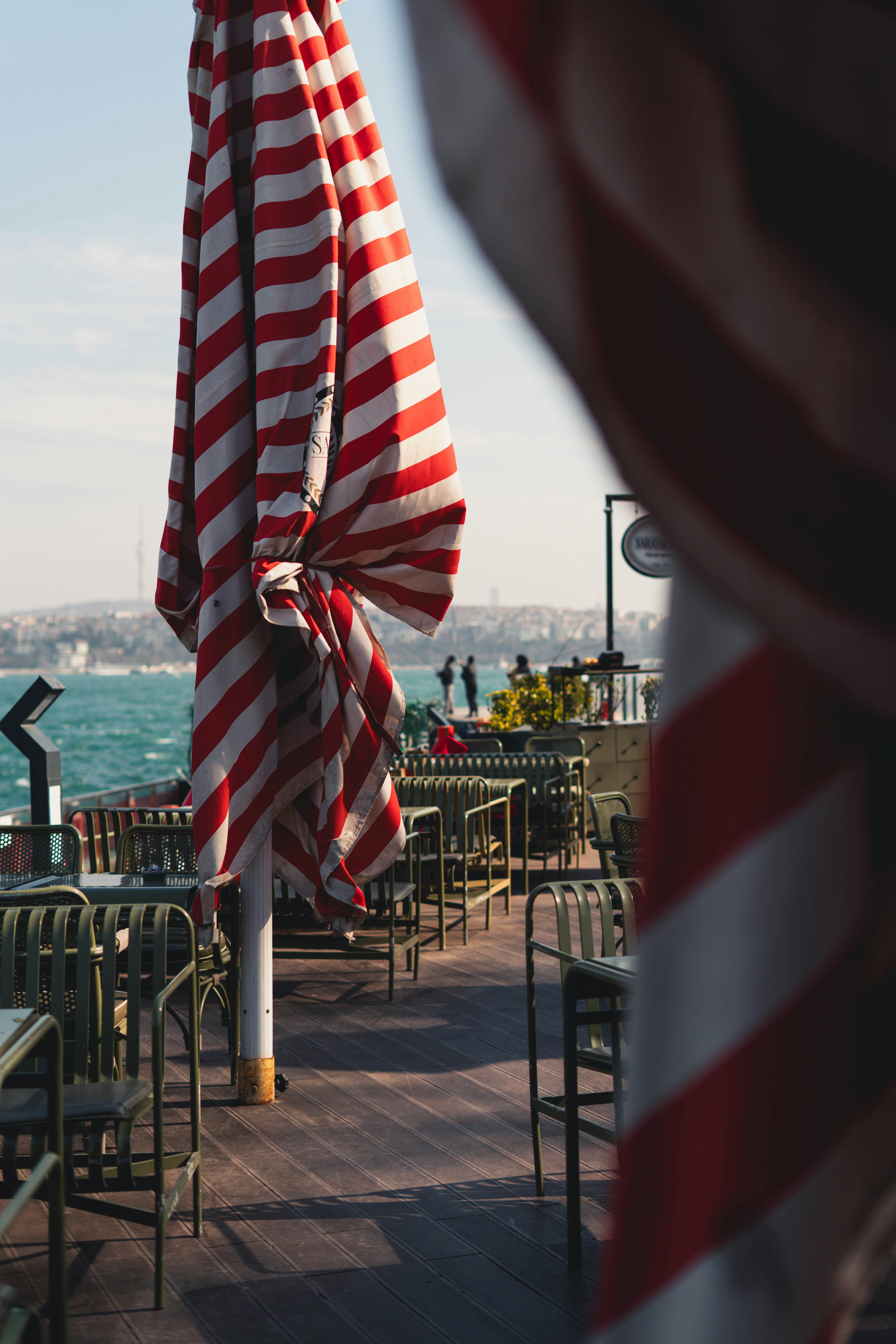  striped parasol threads the seaside terrace into focus