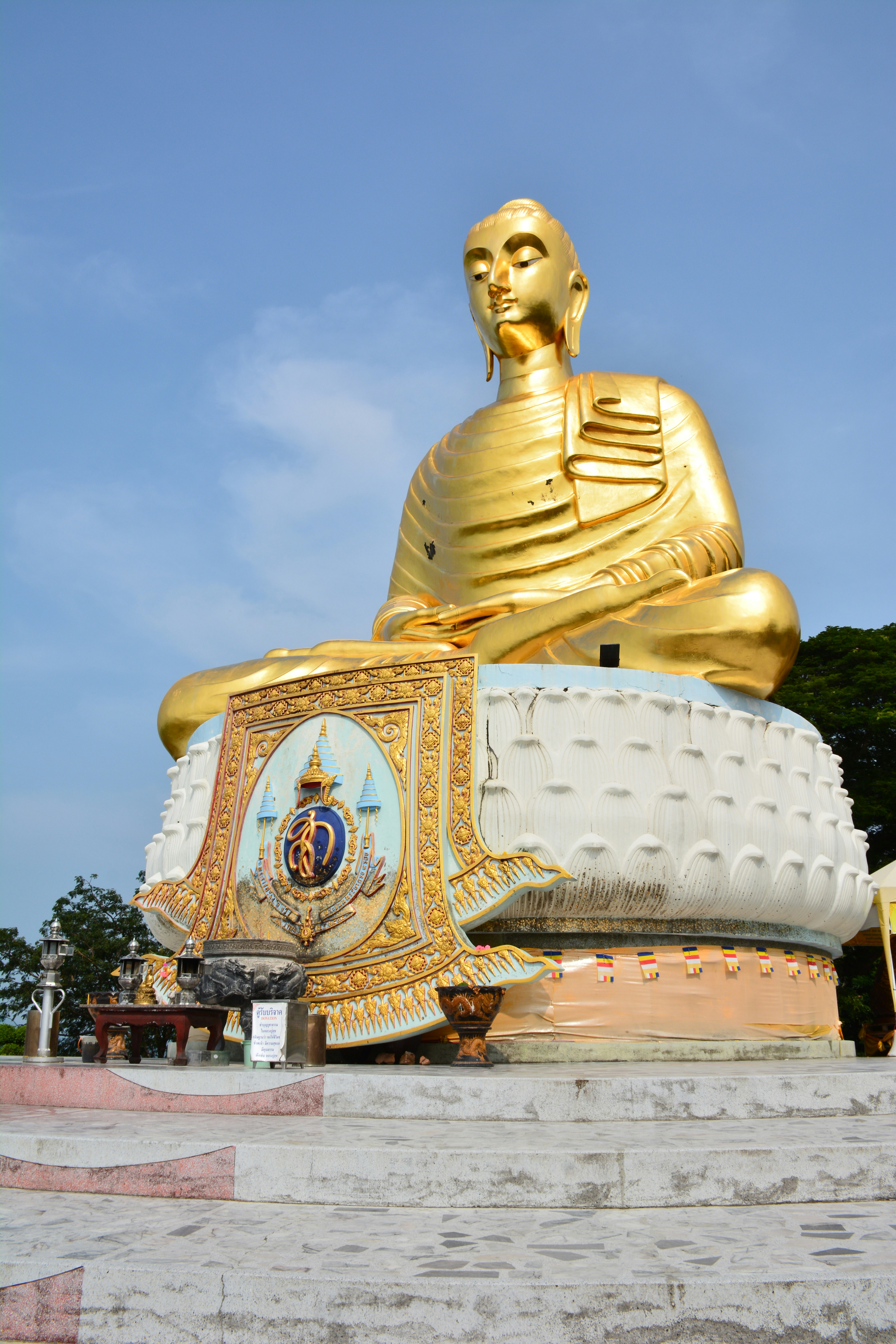 Golden Buddha Ascending: A Majestic Statue Bathed in Sky