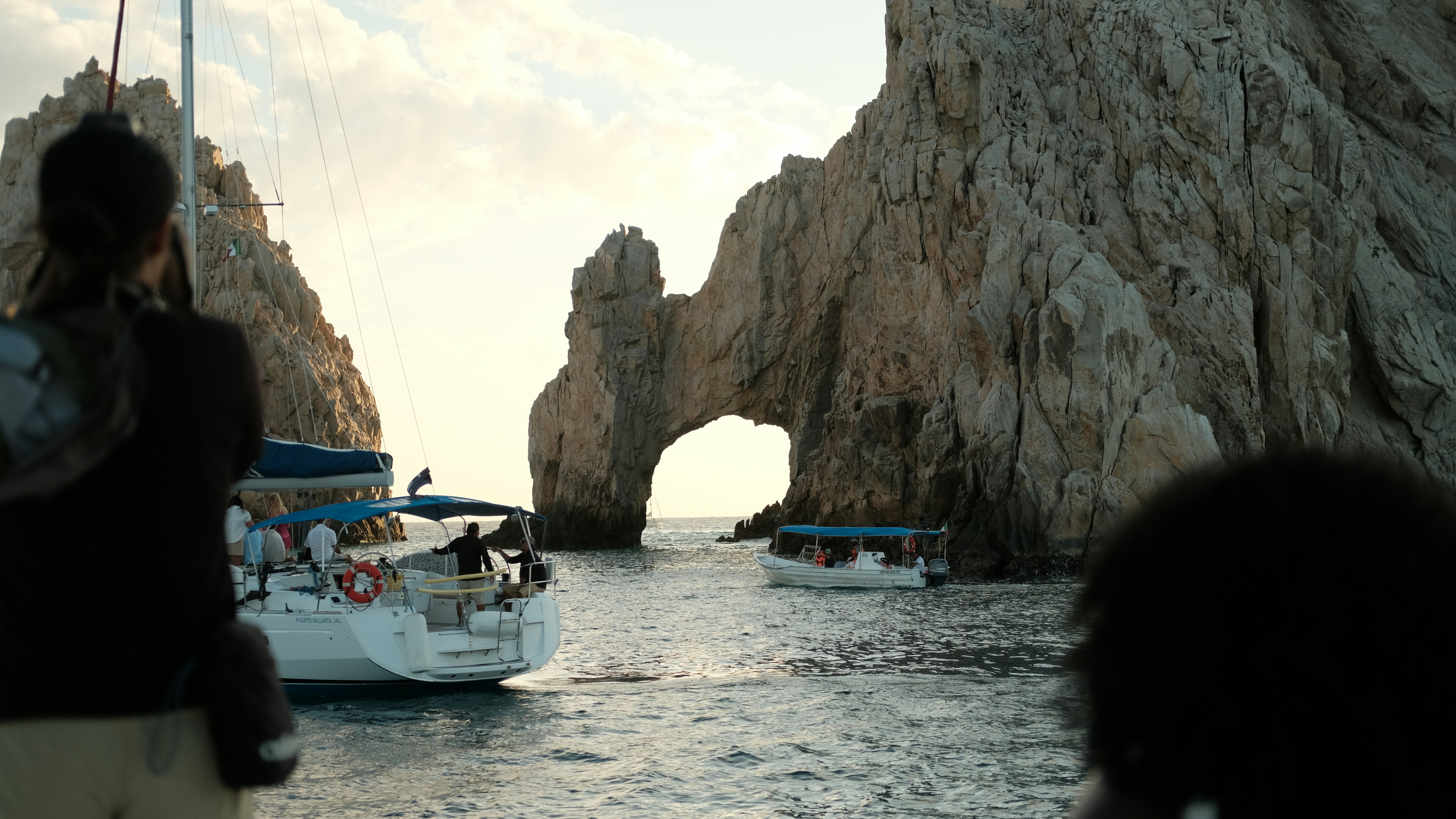 Sea Arch Rendezvous: Boats Framing a Coastal Portrait