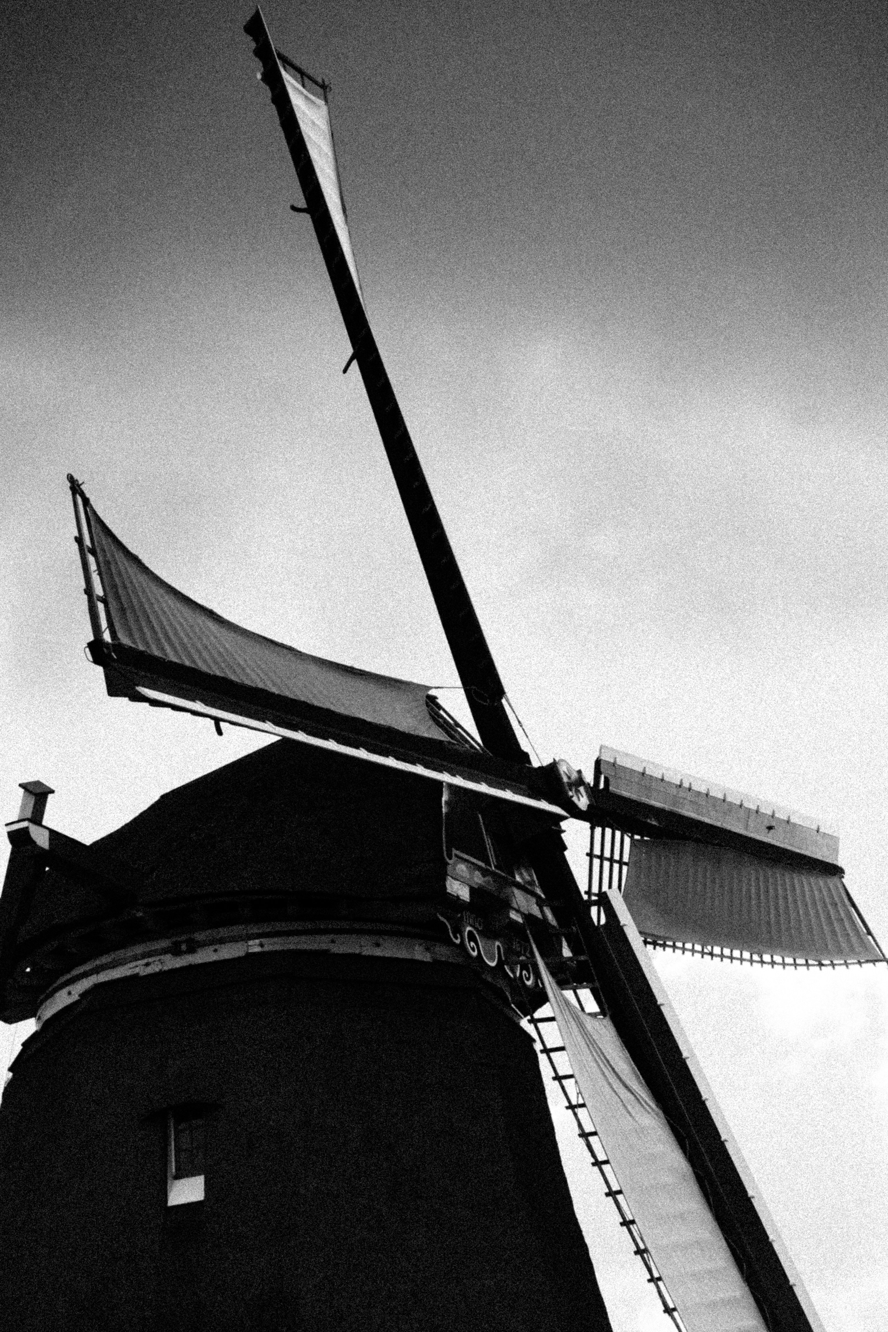 Windmill in Monochrome: Silent Sail Above the Brick