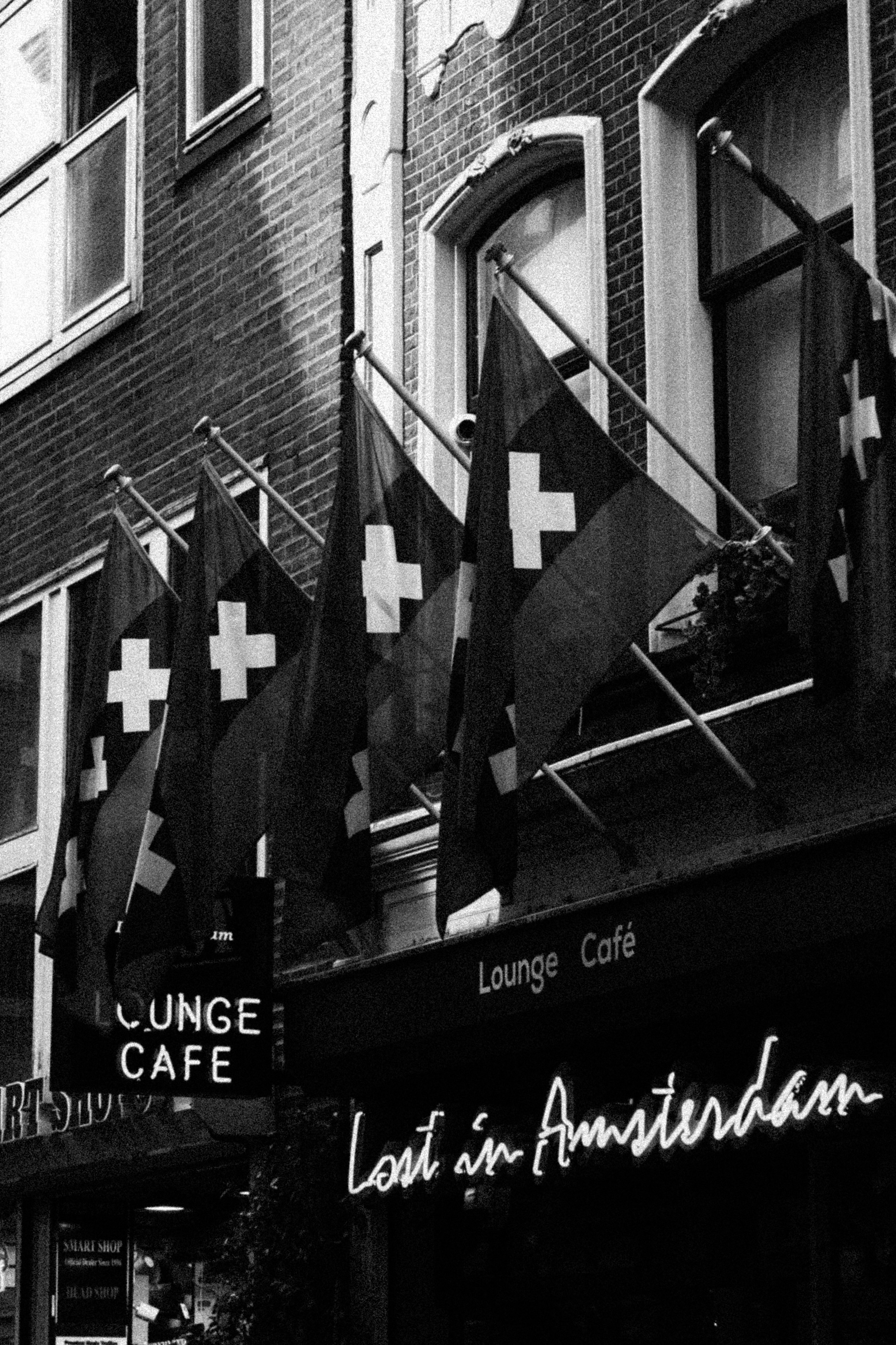 Flags and Neon Script: Nightlife in a Swiss-German Café Corridor