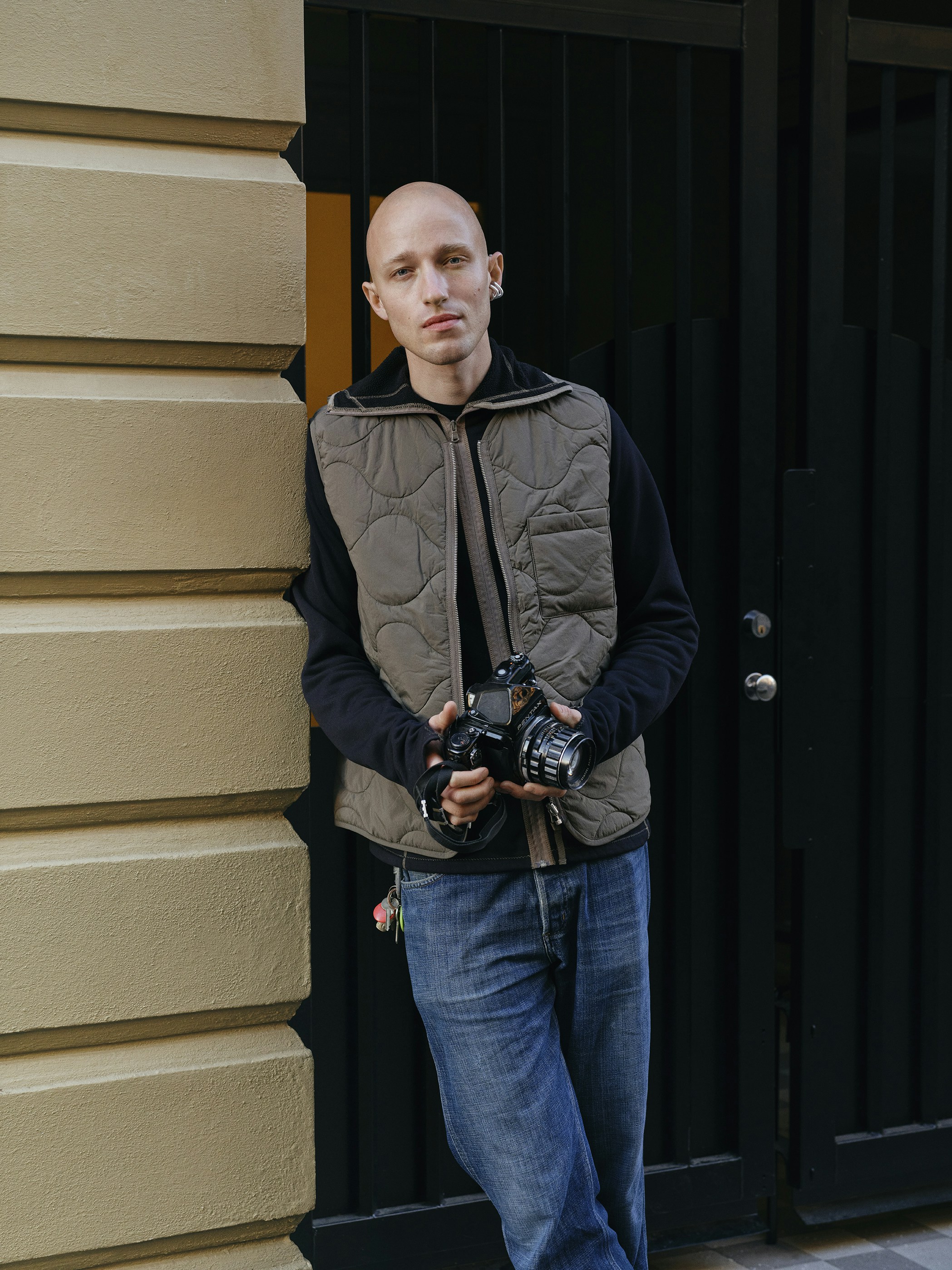 Photographer in Quiet Confidence at a Sunlit Doorway