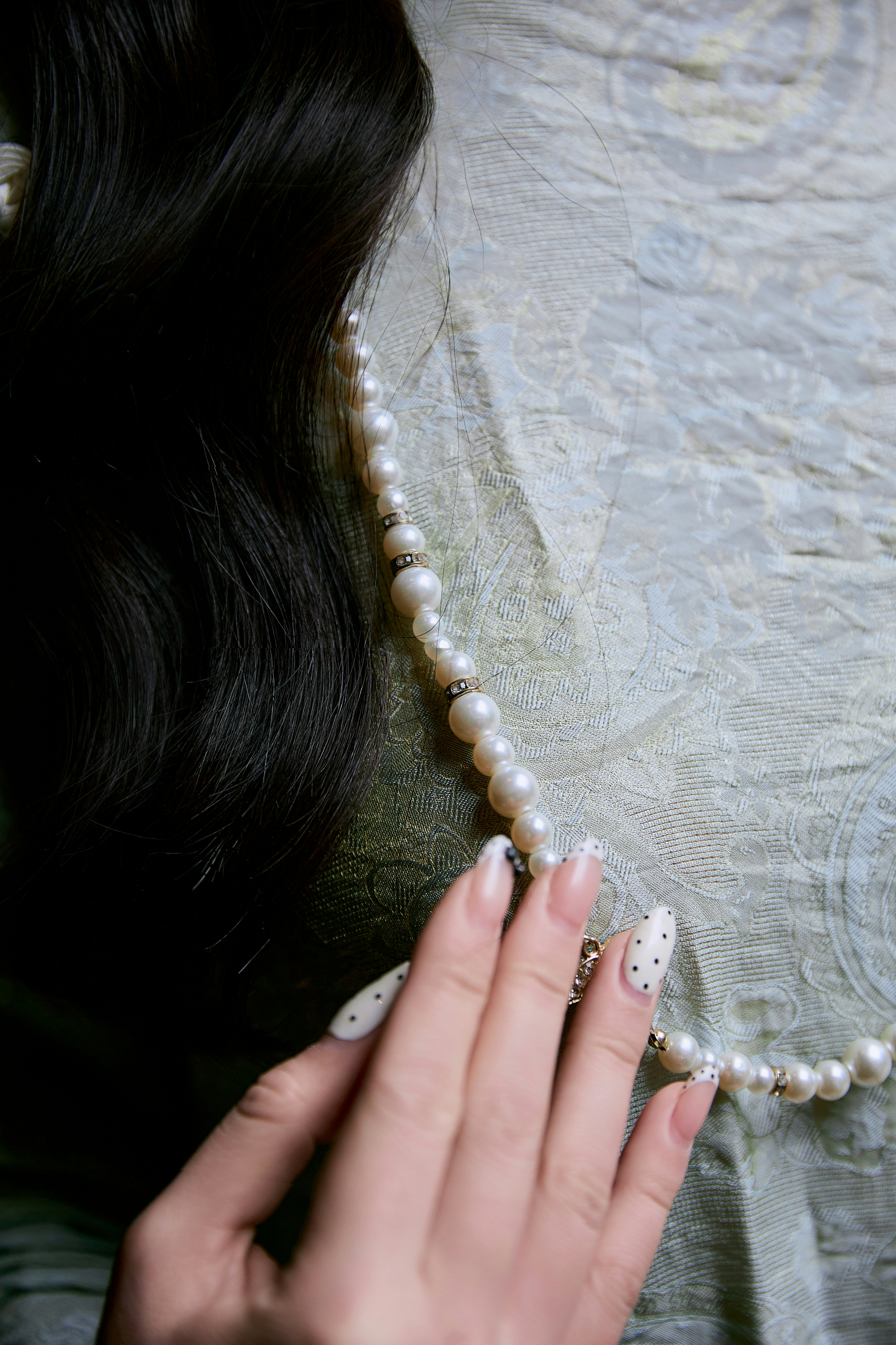 Pearl Necklace Draped Across Lace: Subtle Glamour in Soft Light