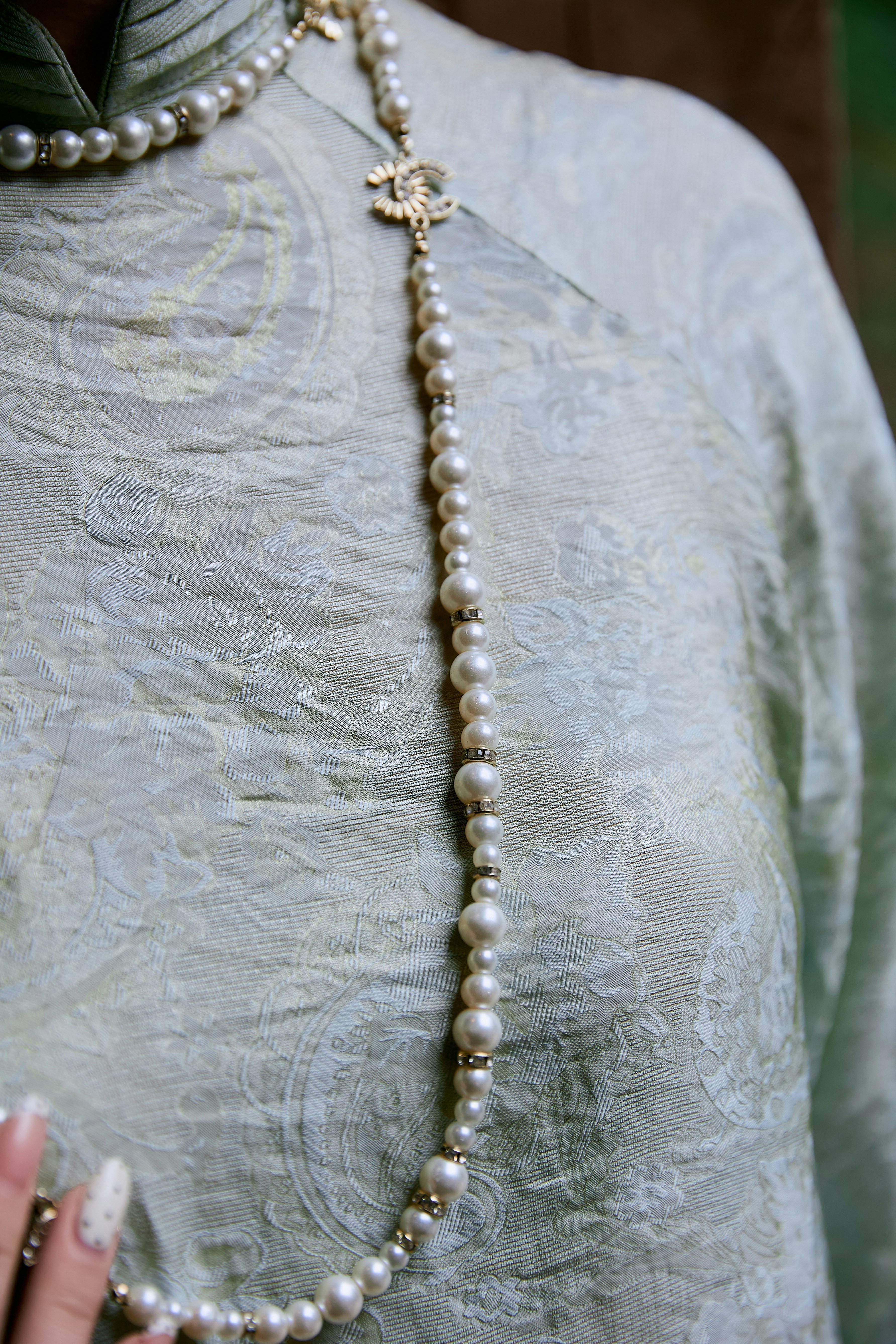 Pearl Necklace Draped Across a Textured Traditional Garment