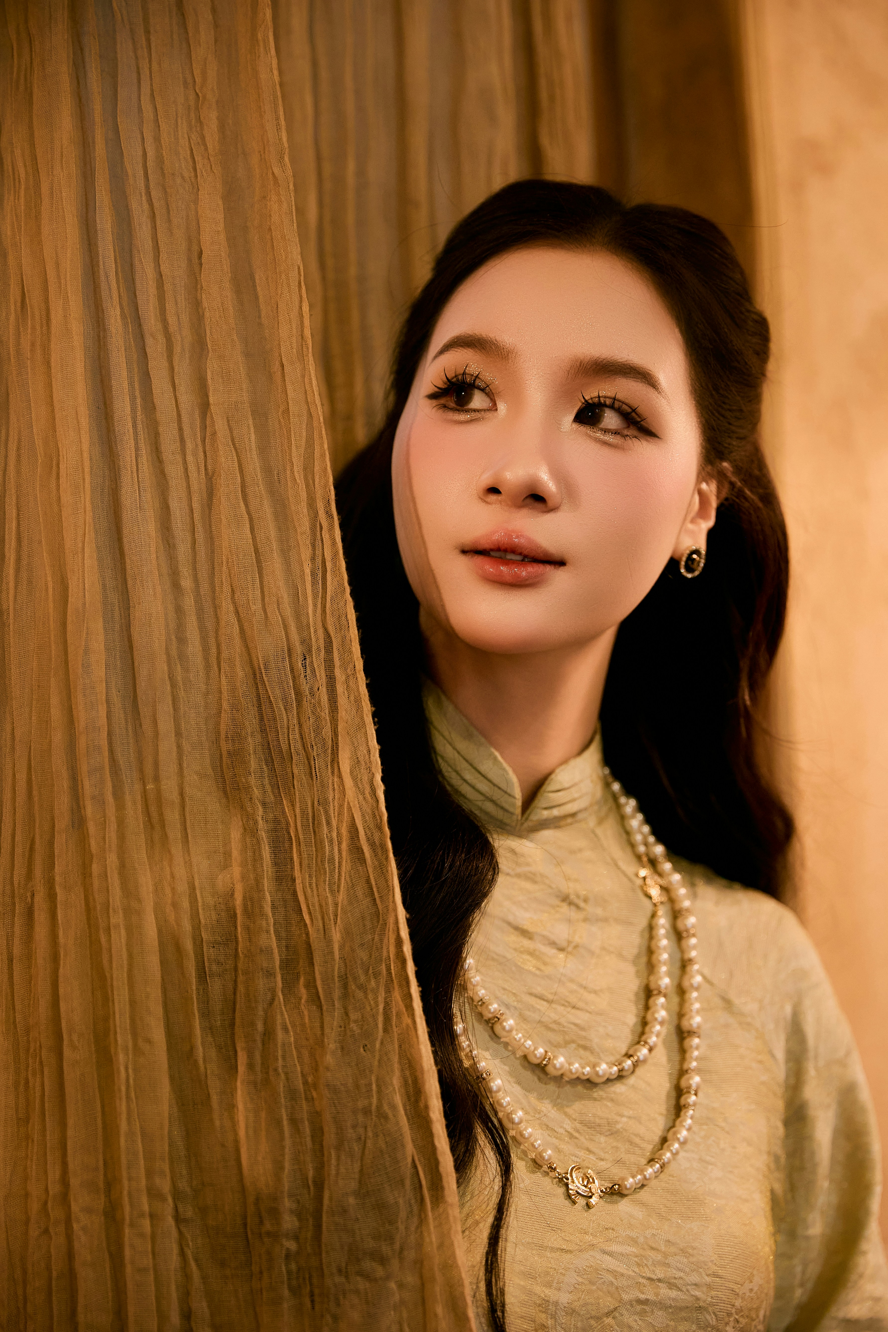 Portrait of Quiet Grace Behind Draped Velvet