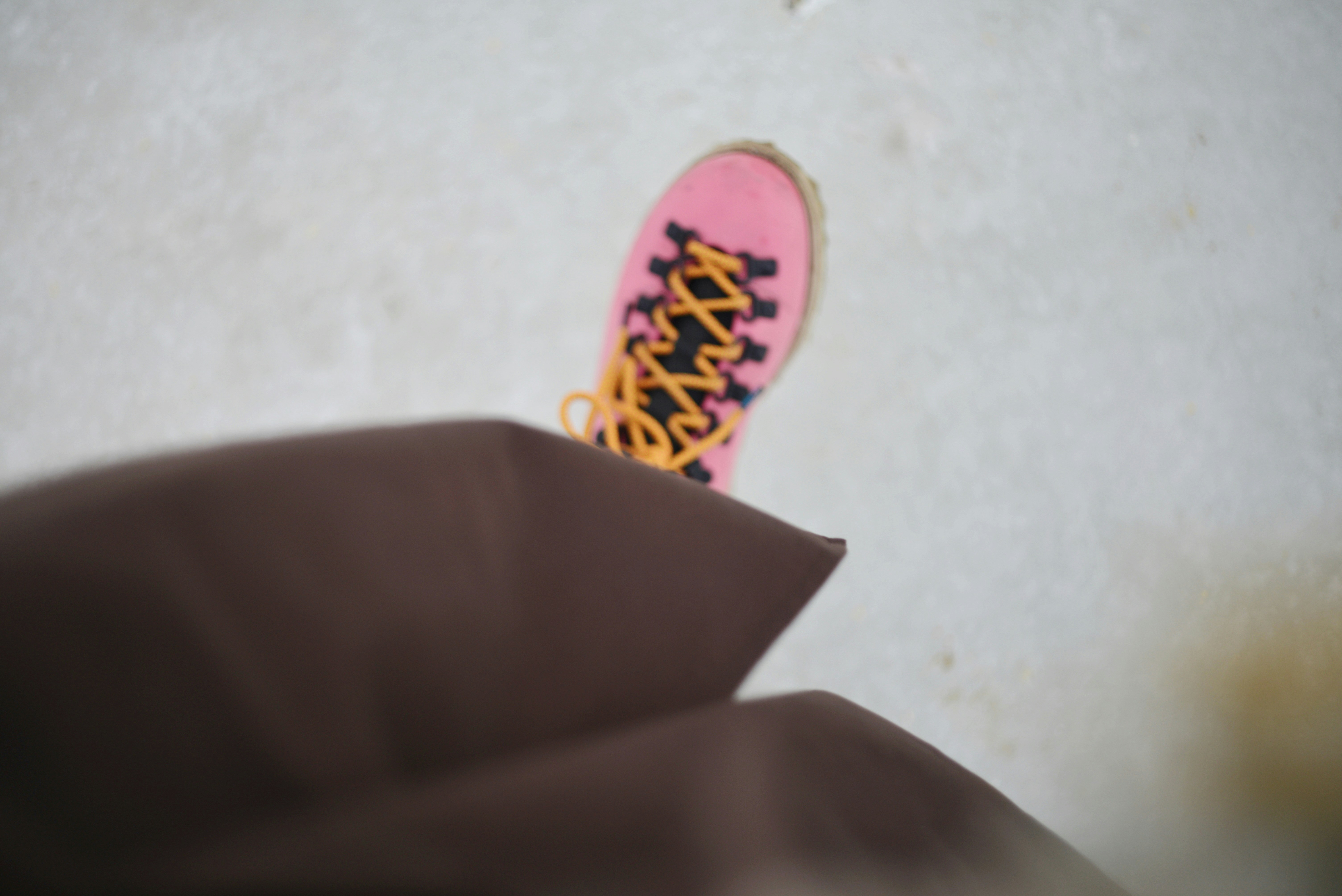 Pink Sneaker in the Blur: A Ground-Level Peek