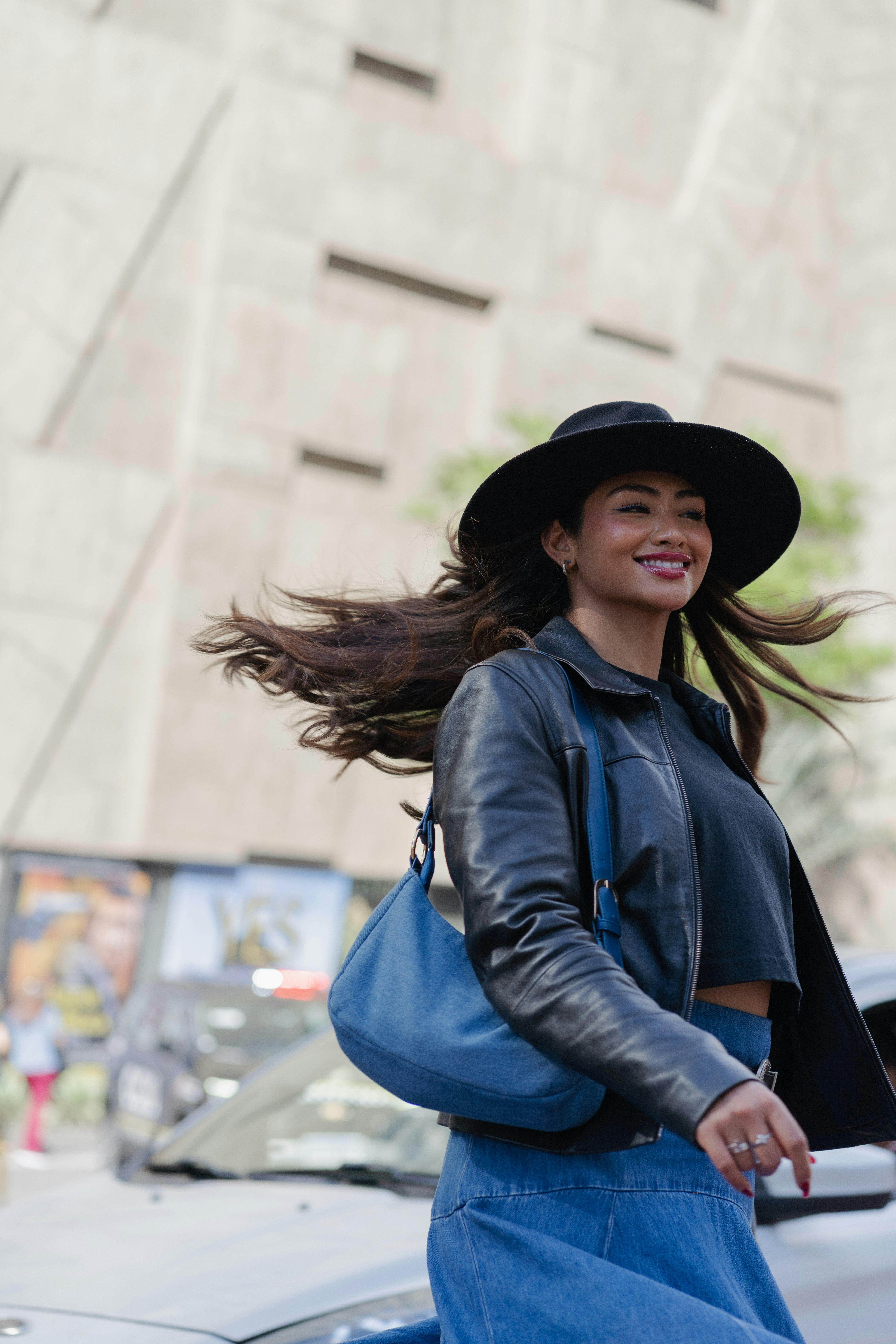 Midday breeze: a confident stride under a wide-brim silhouette