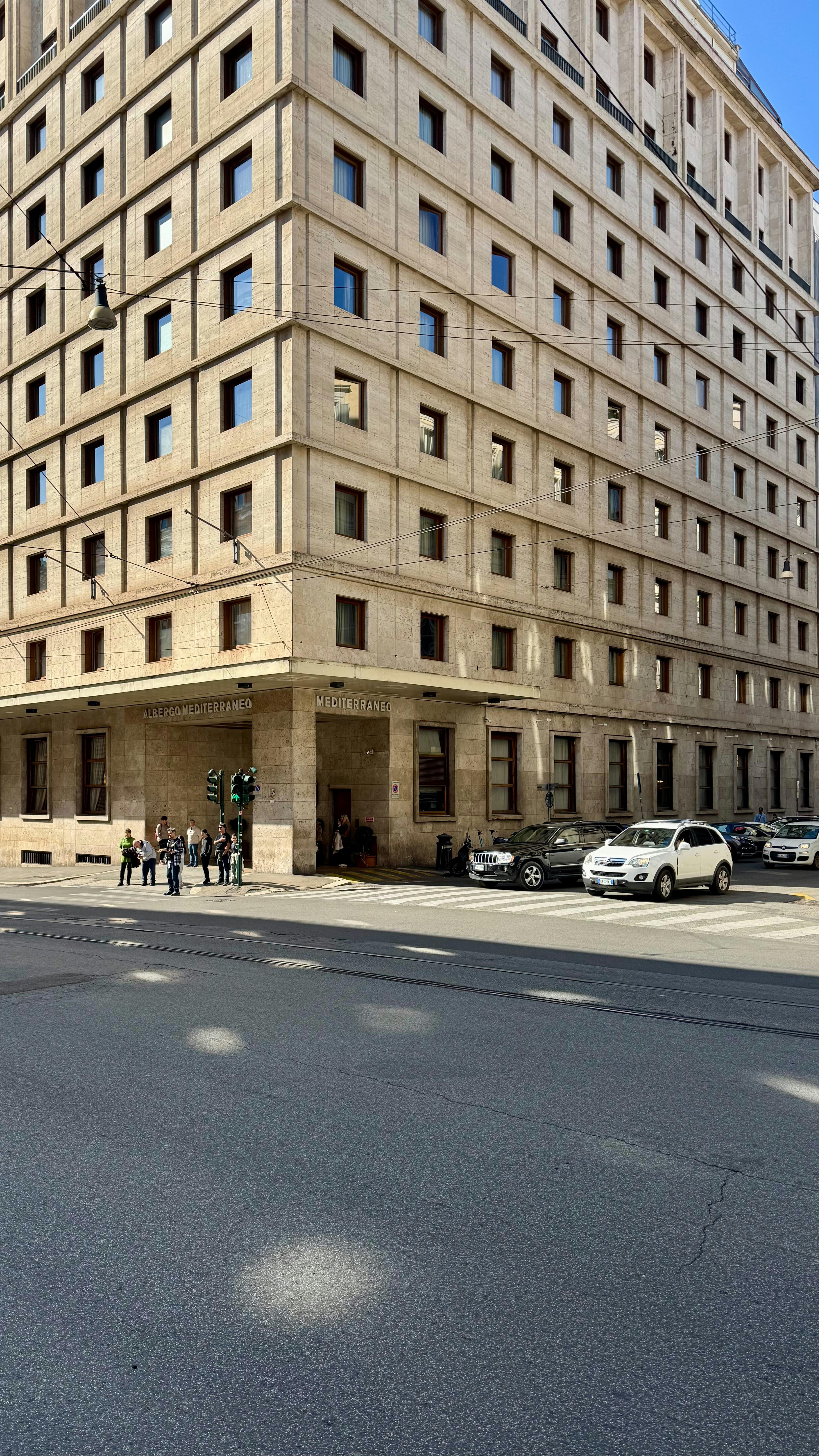 Cornered by design: a sunlit city block with a grid of windows