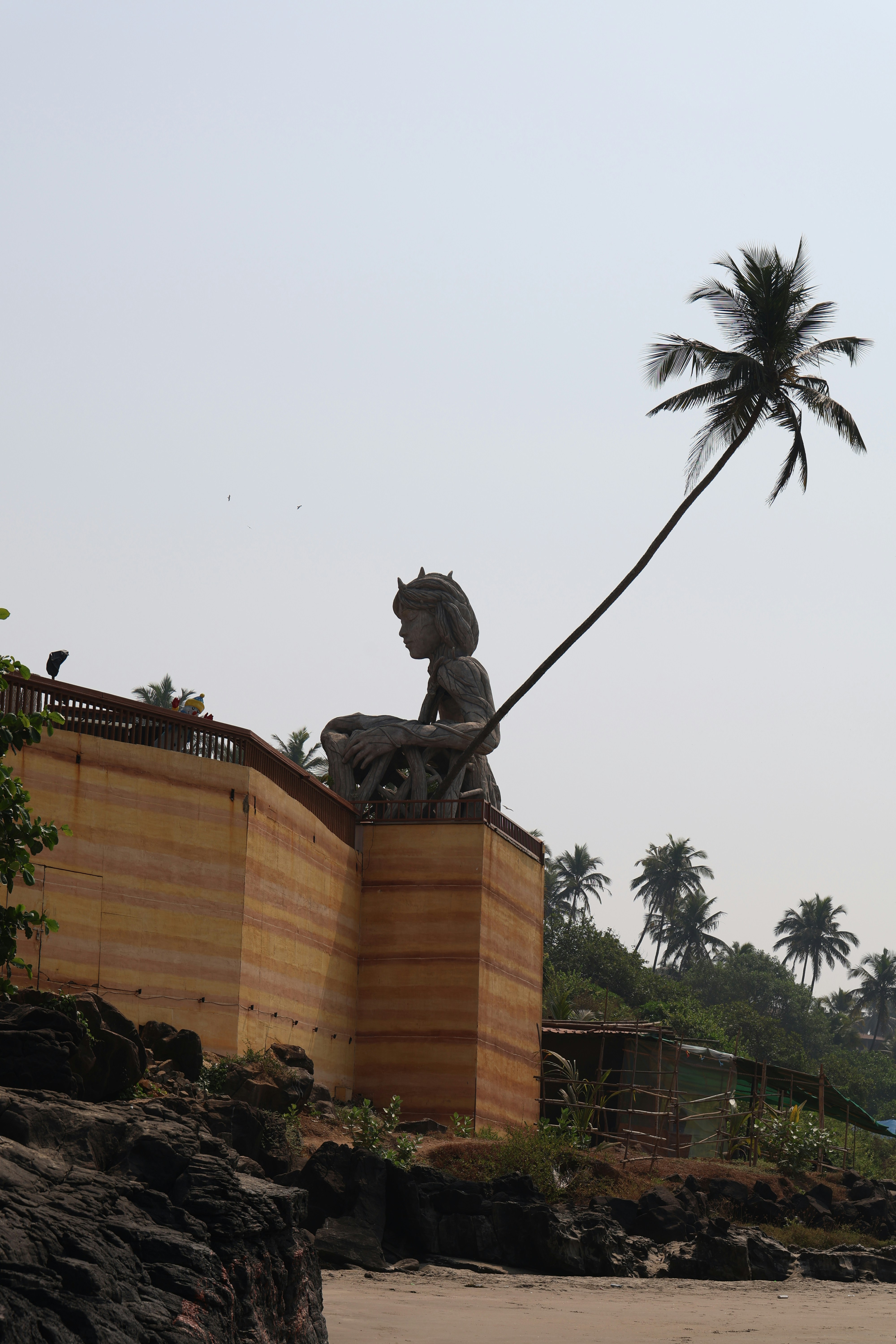 Harbor of Giants: A Seated Figure and a Slender Palm