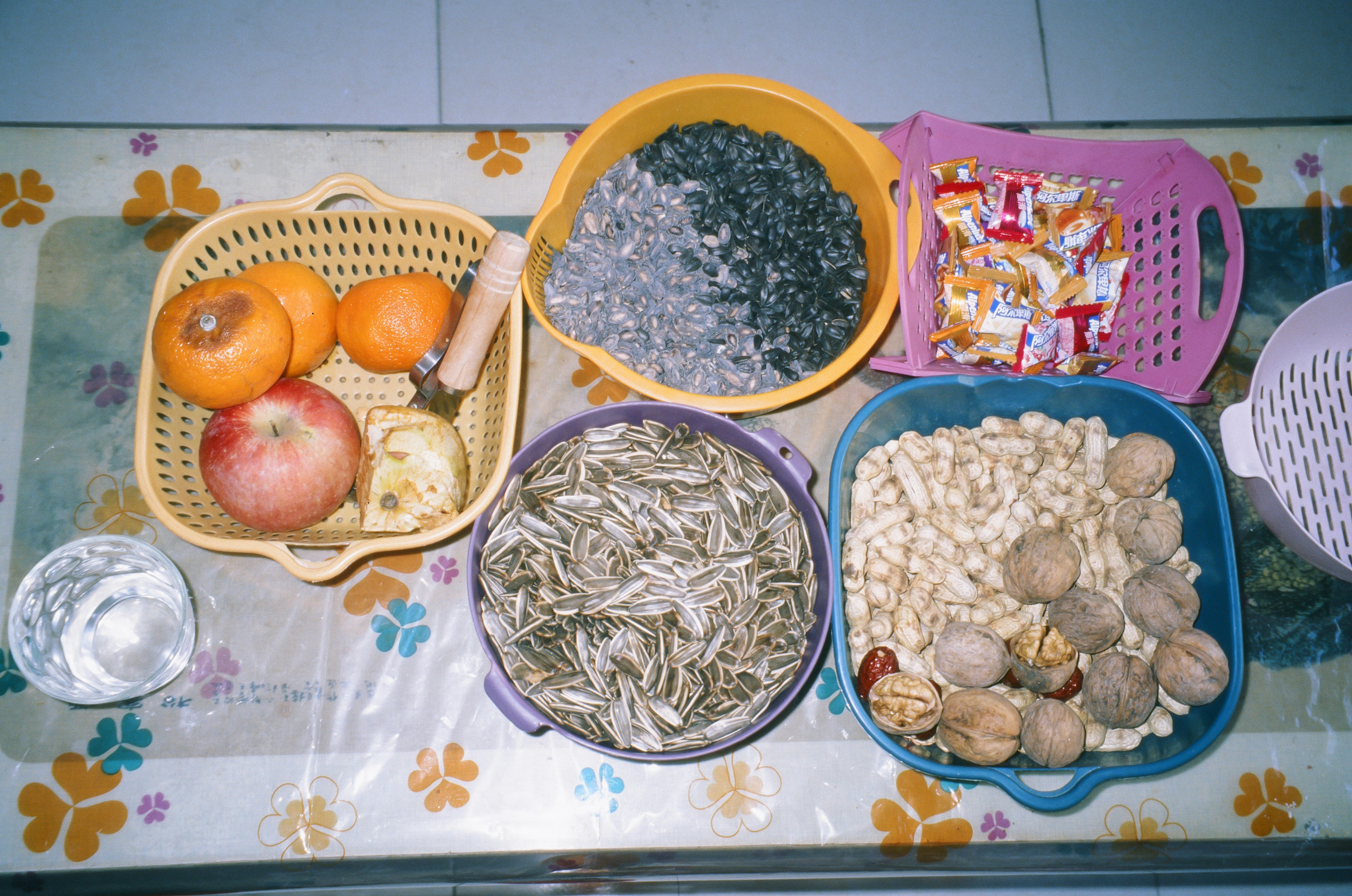 Various nuts, fruits, and seeds arranged in bowls.
