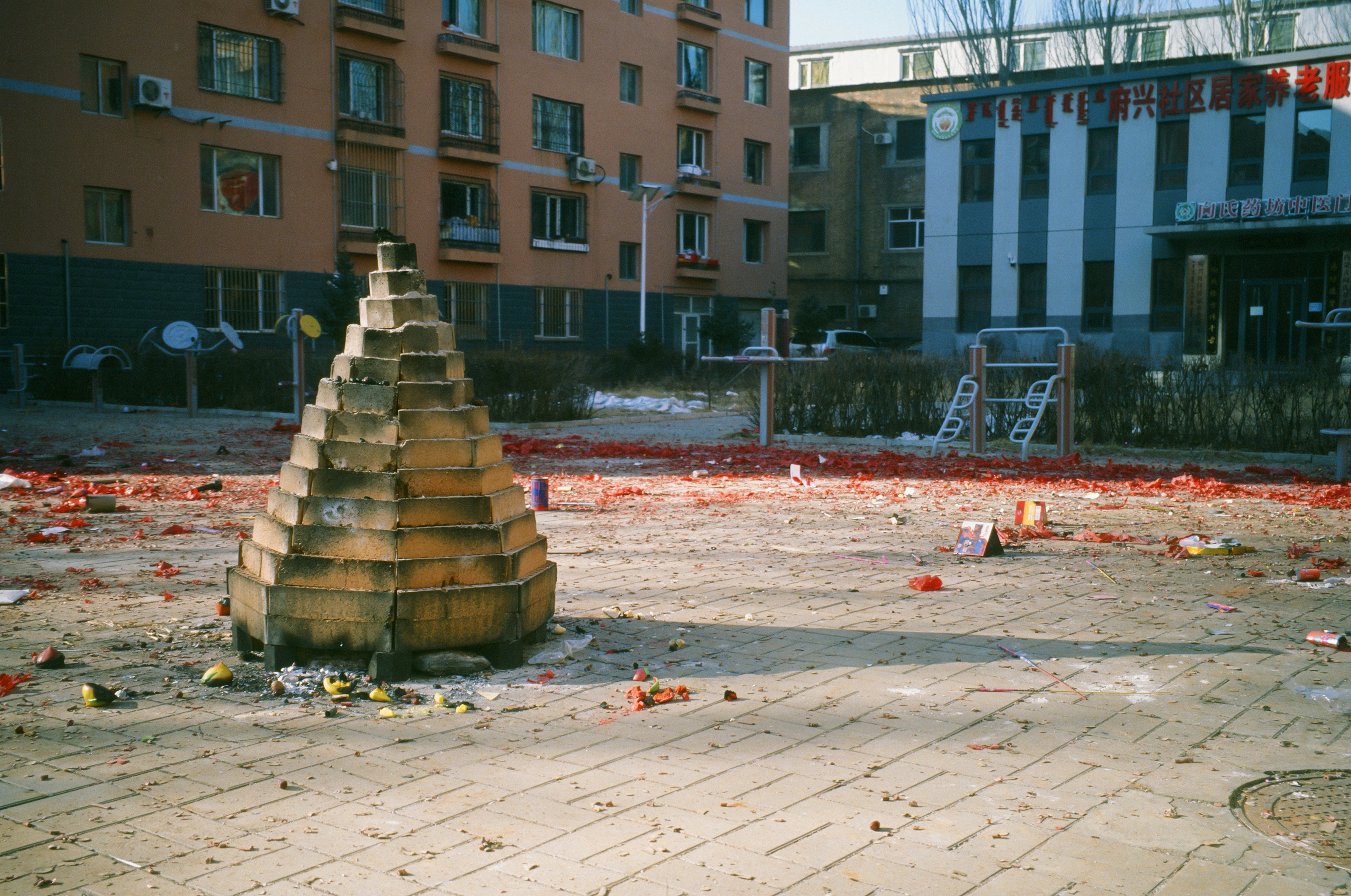 A tiered concrete structure in a debris-strewn courtyard.