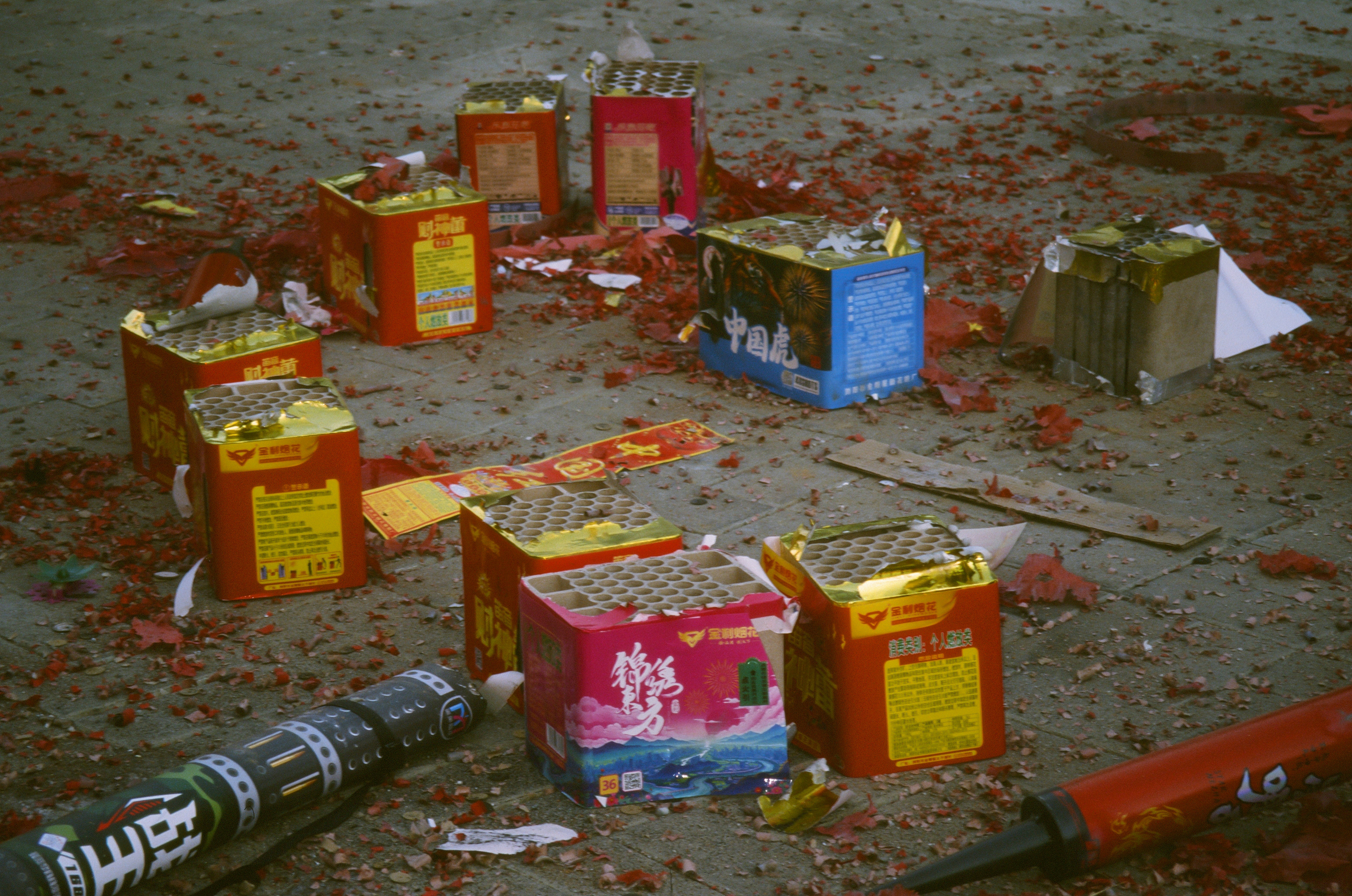Discarded fireworks and debris scattered on the ground