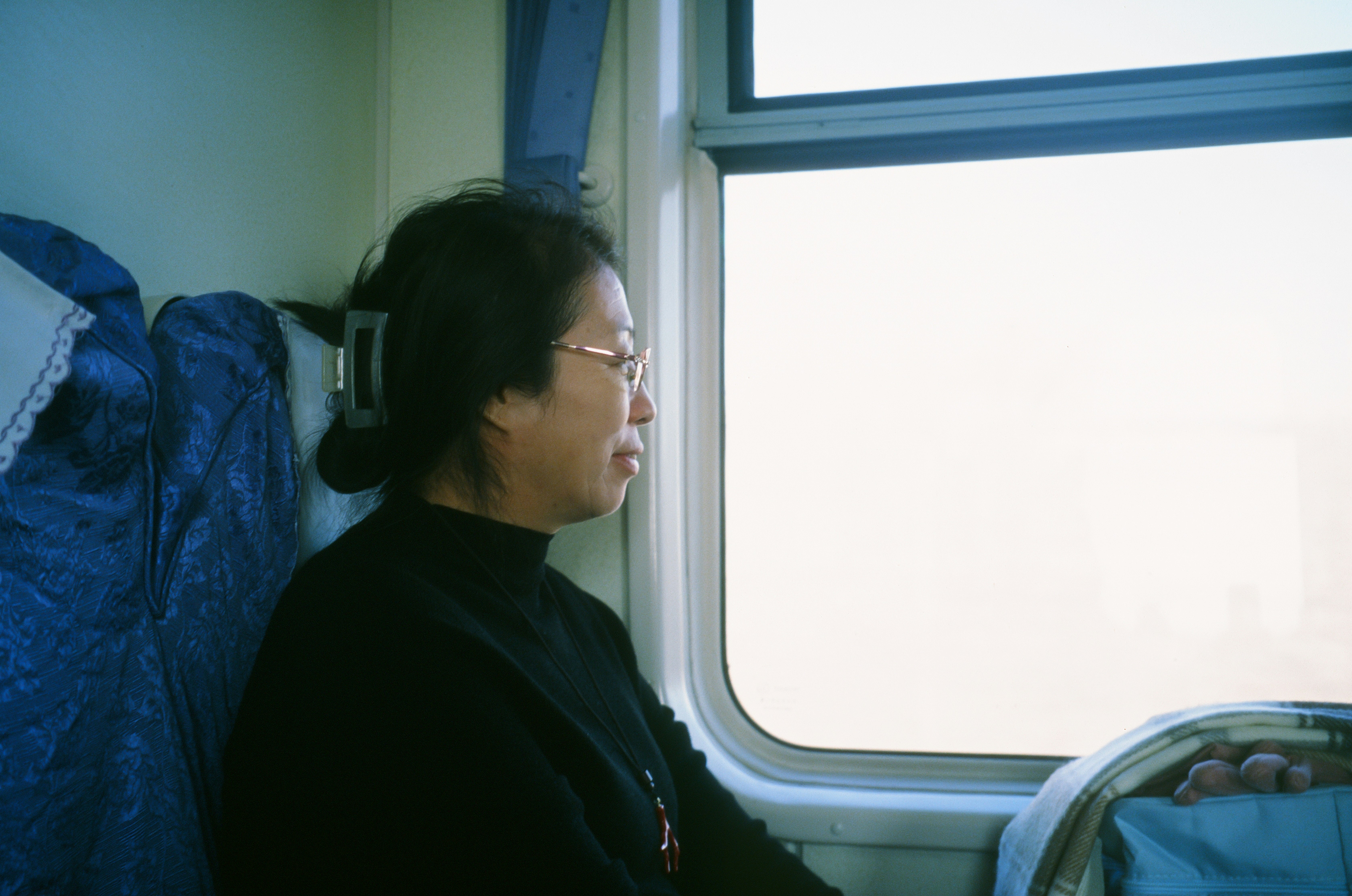 Woman looking out of a train window