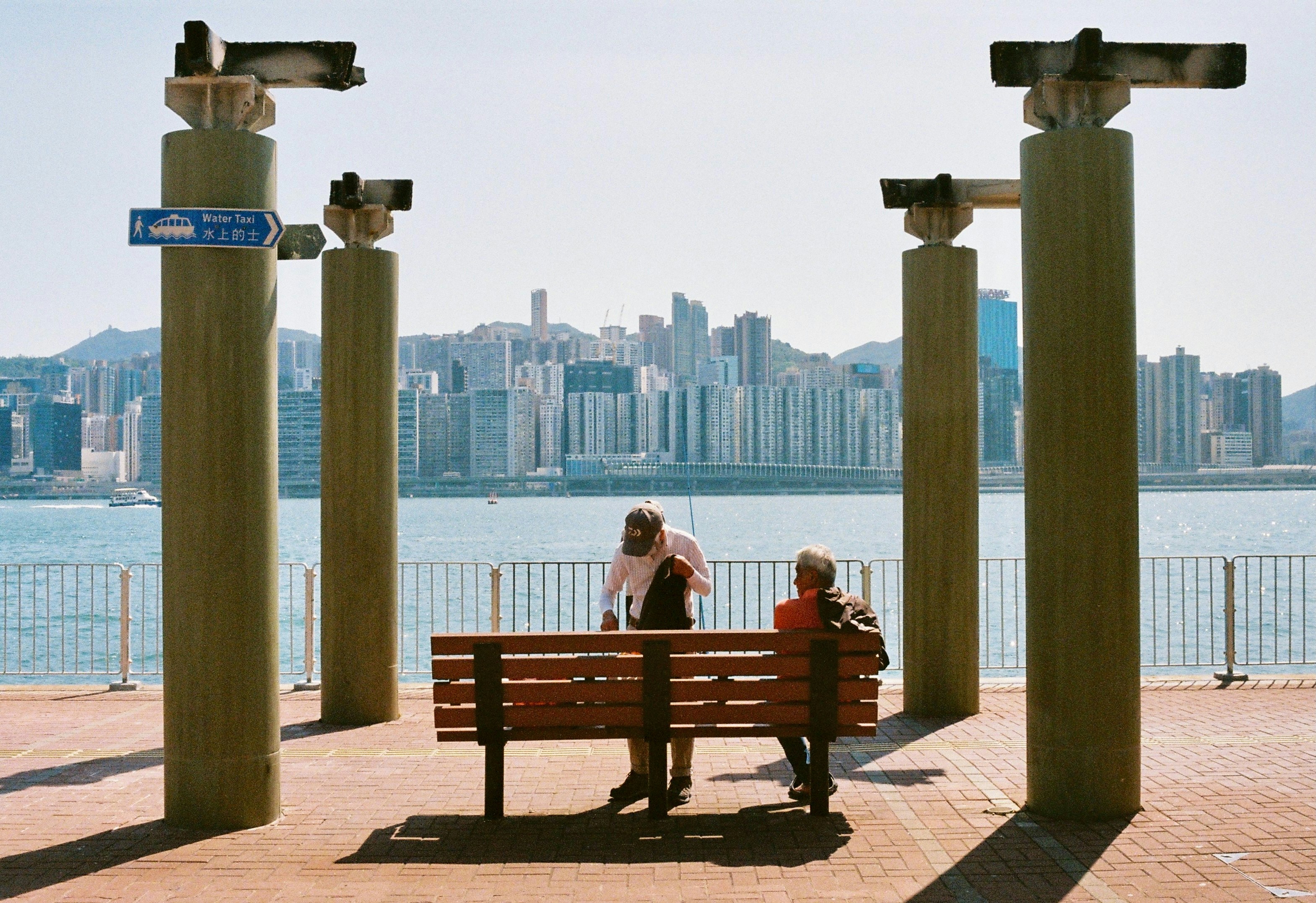 Bench by the Bay: silhouettes, cityscape, and sea breeze