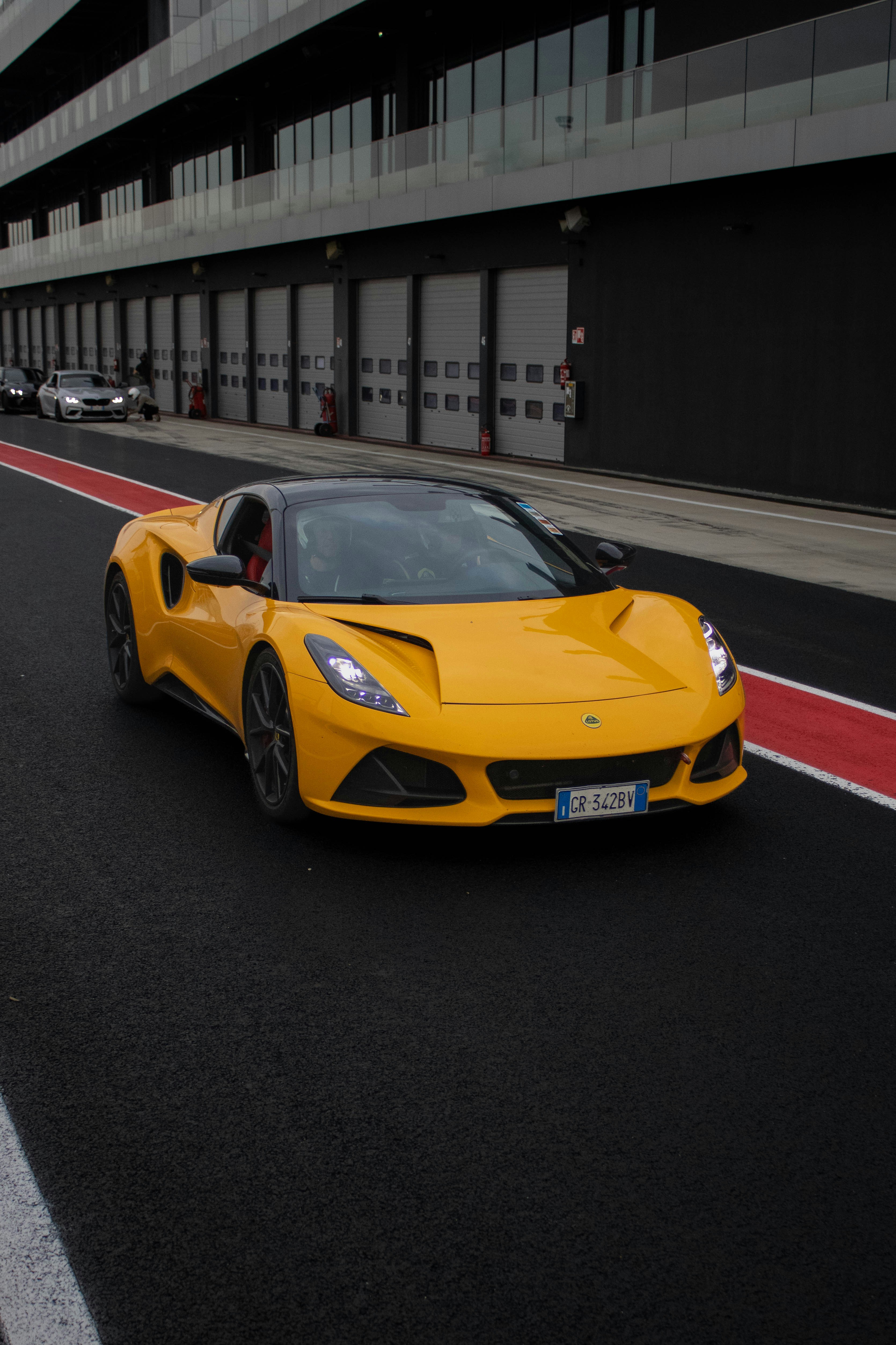 Thunder in Yellow: A Sportscar Roars onto the Pit Lane