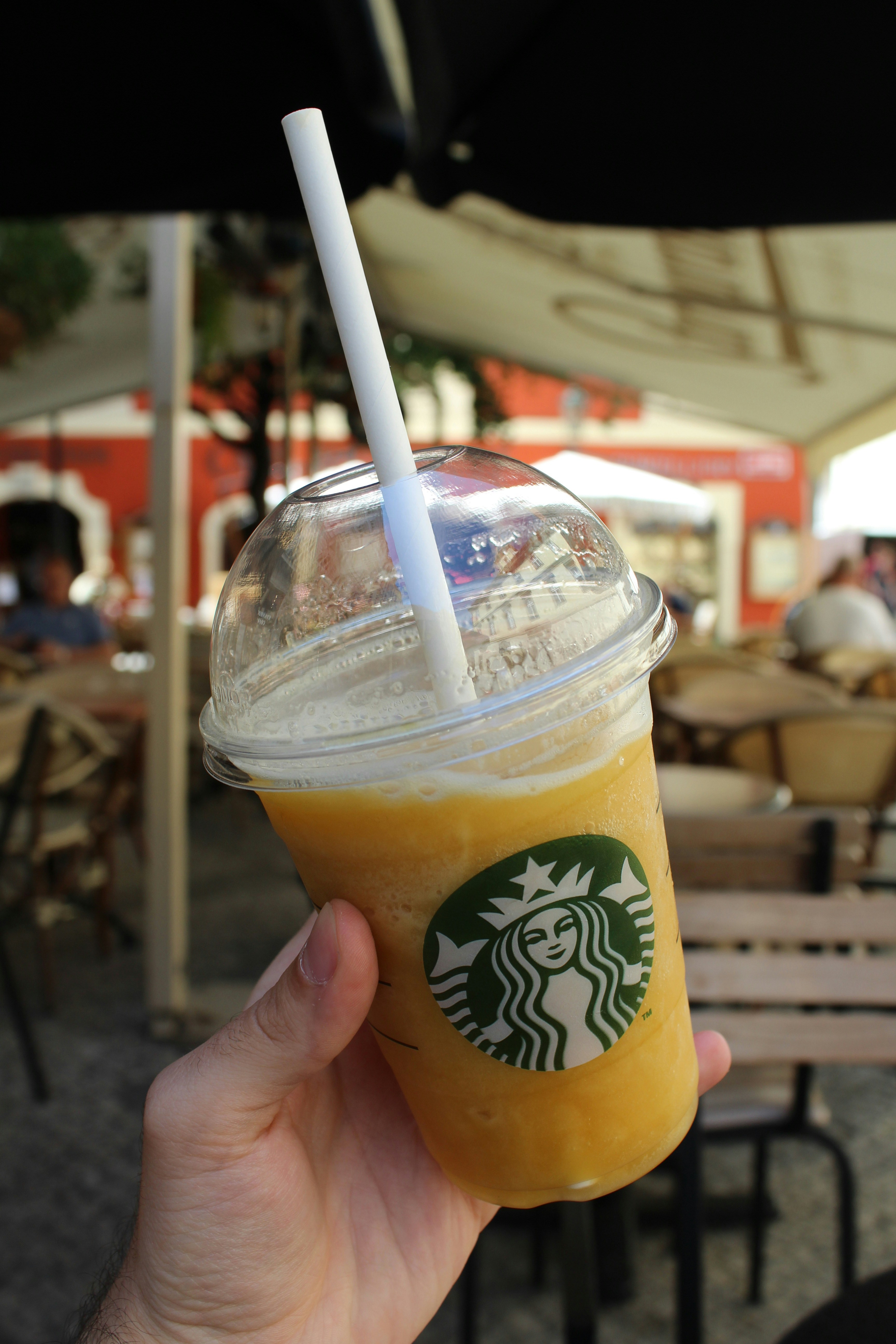 Starbucks Cup at Café Terrace: A Sunlit Drink in Focus