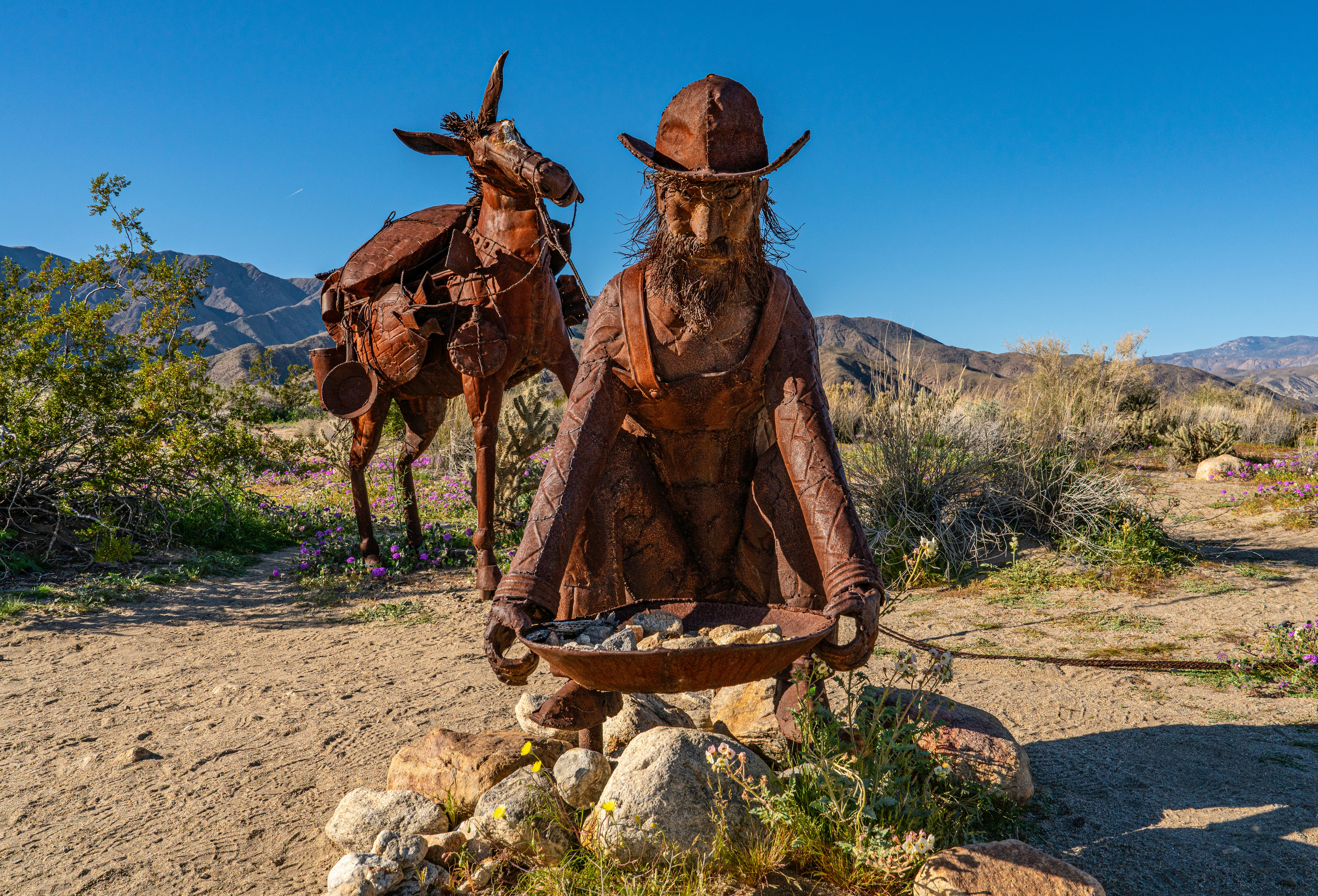 Desert Wardens: Cloth-crowned Figures guarding a sunlit ridge