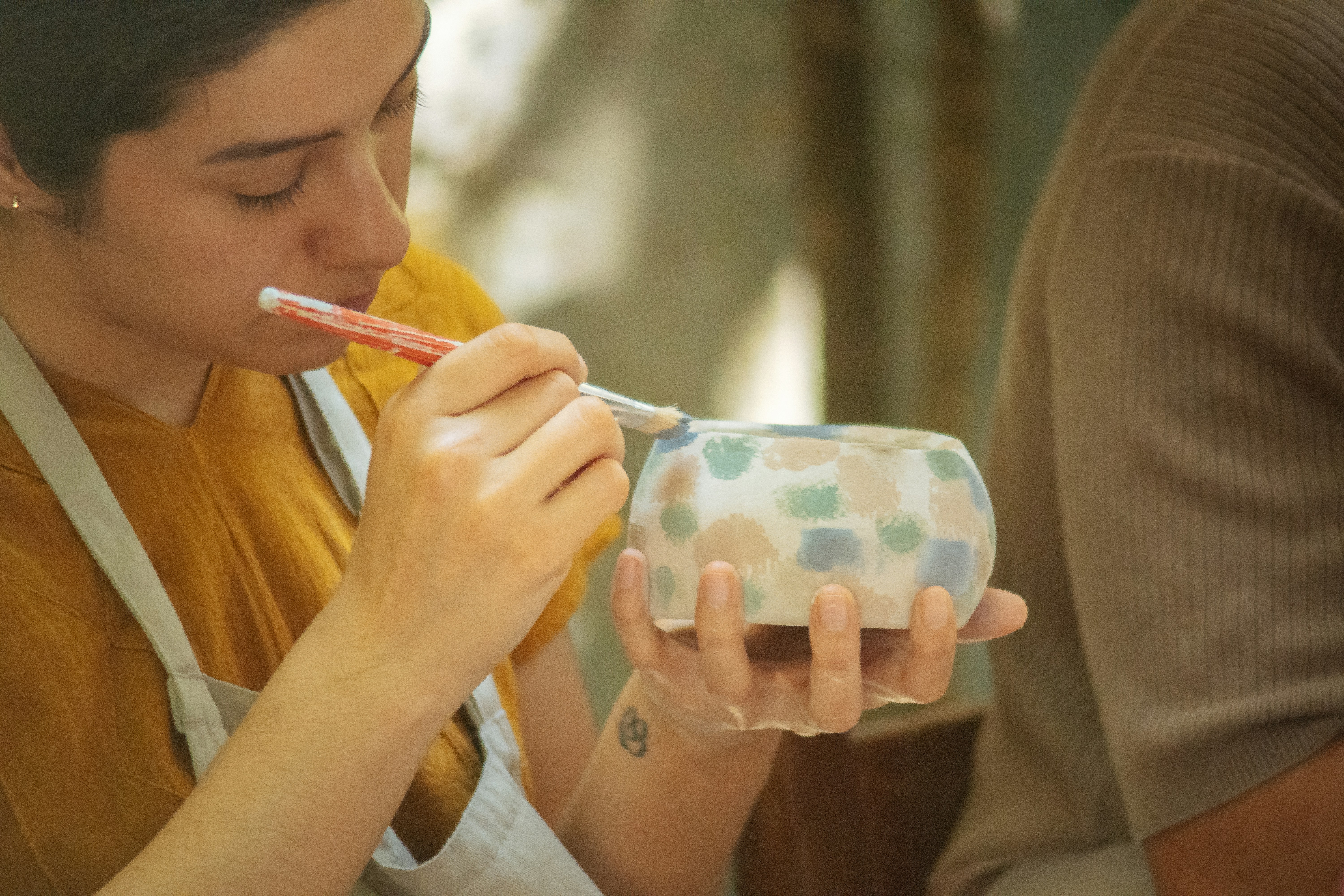Brushstrokes of Focus: A Quiet Moment with a Ceramic Vessel