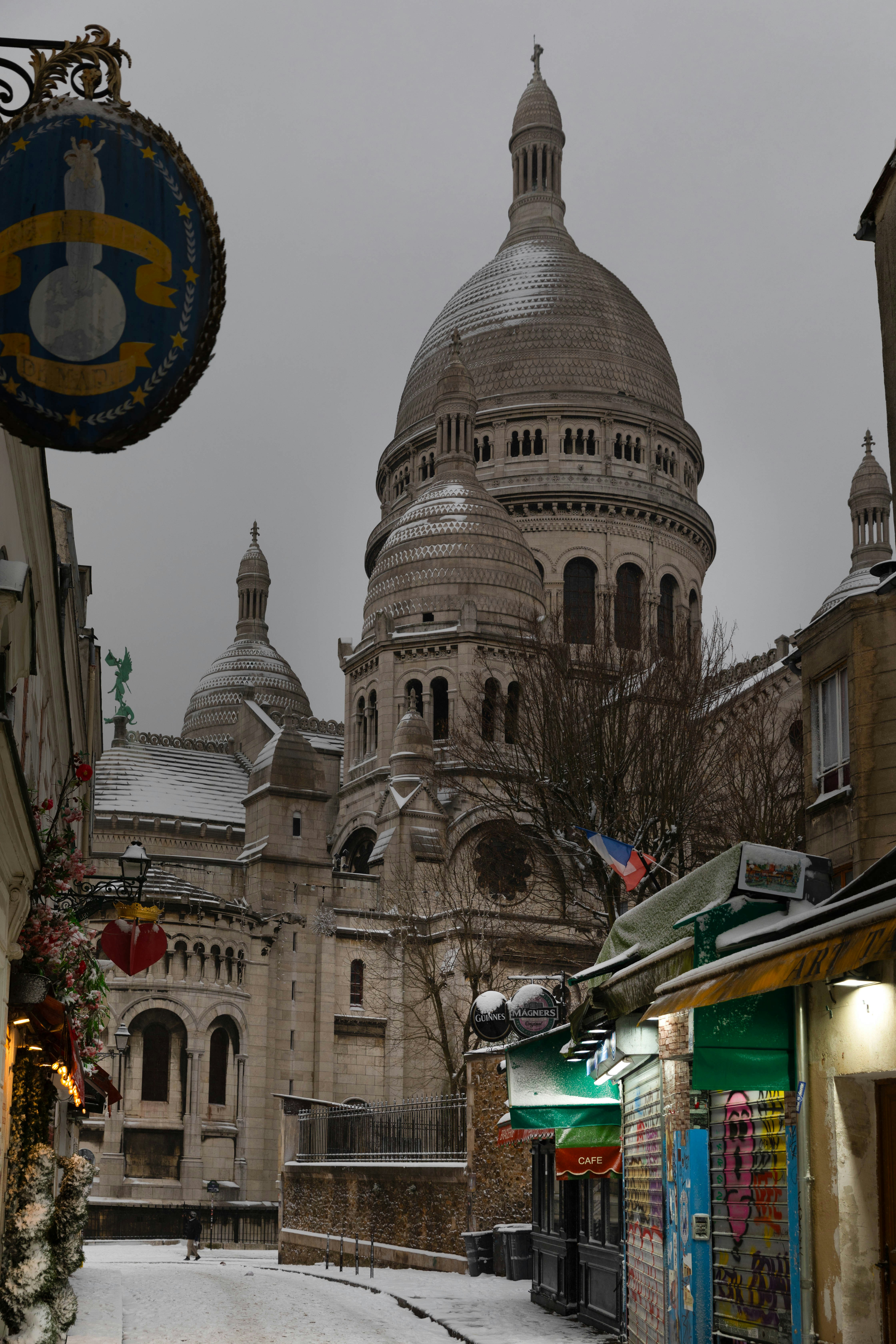 Saint-Sacred Skyline: Sacré-Cœur Emerges Over a Snowlit Montmartre Lane