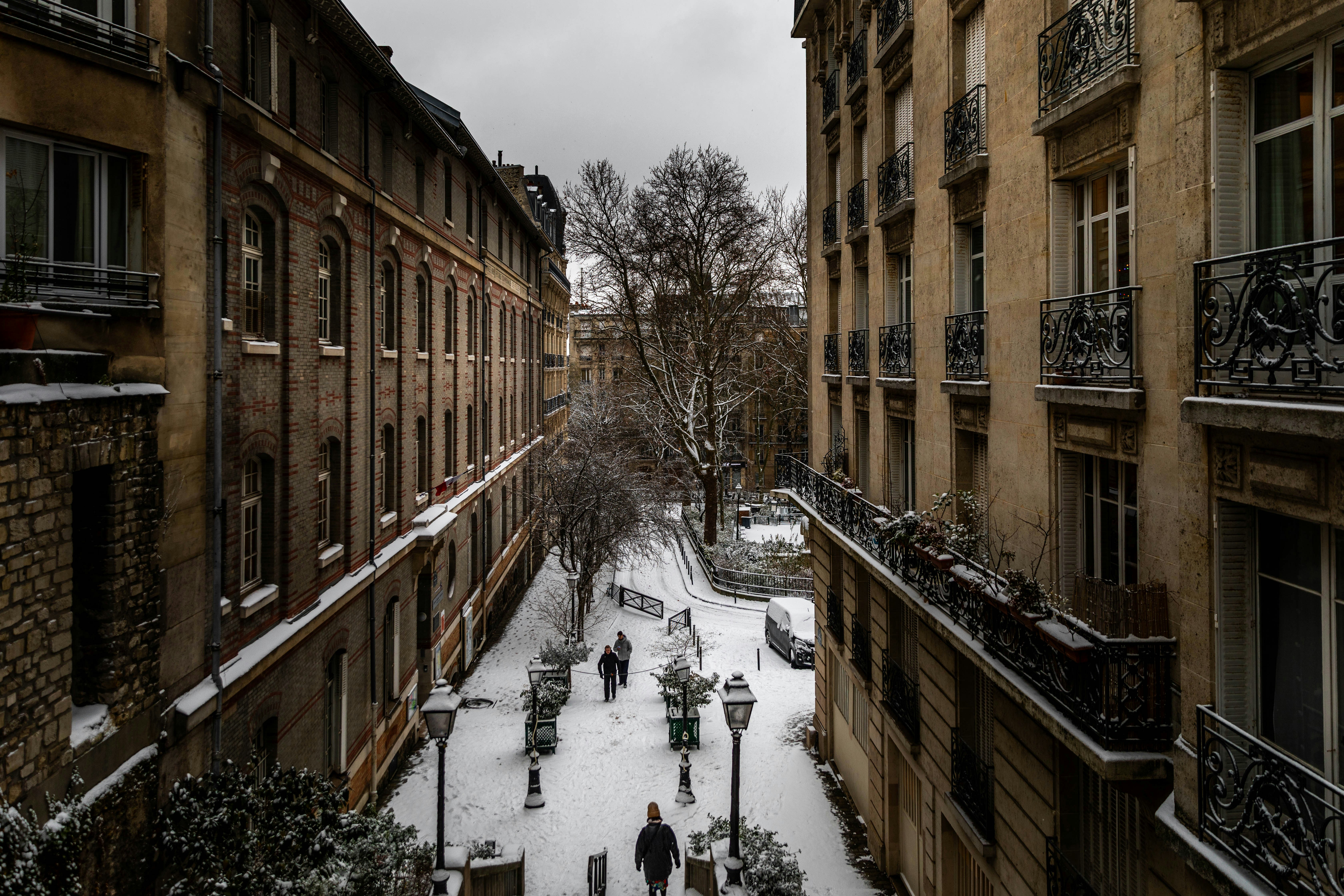 Snowy Court, Velvet Shadows: A Parisian Passage Framed by Balconies
