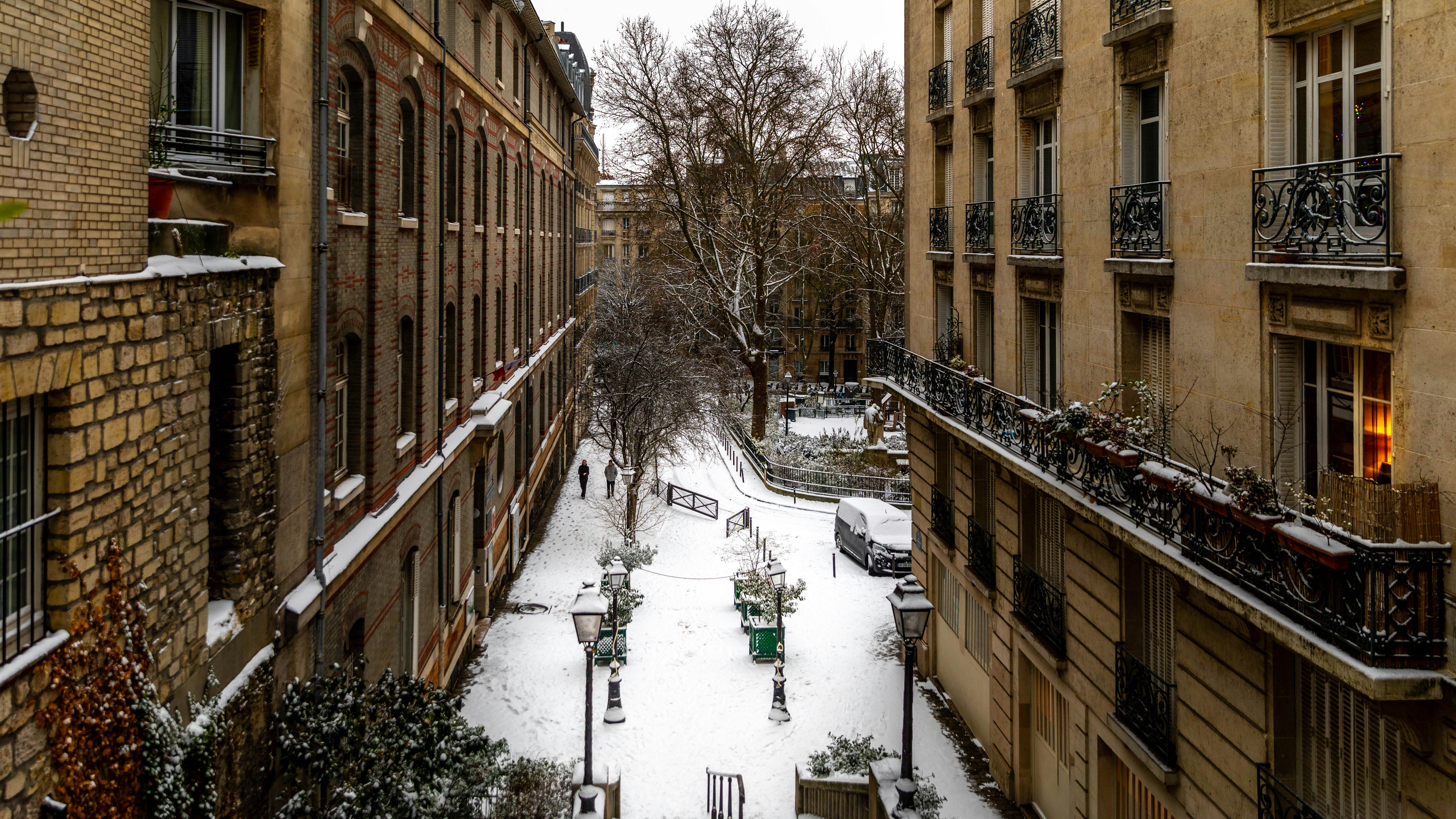 Snowbound Alley: Quiet Parisian Courtyard as Snow Quietly Turns the Street to White