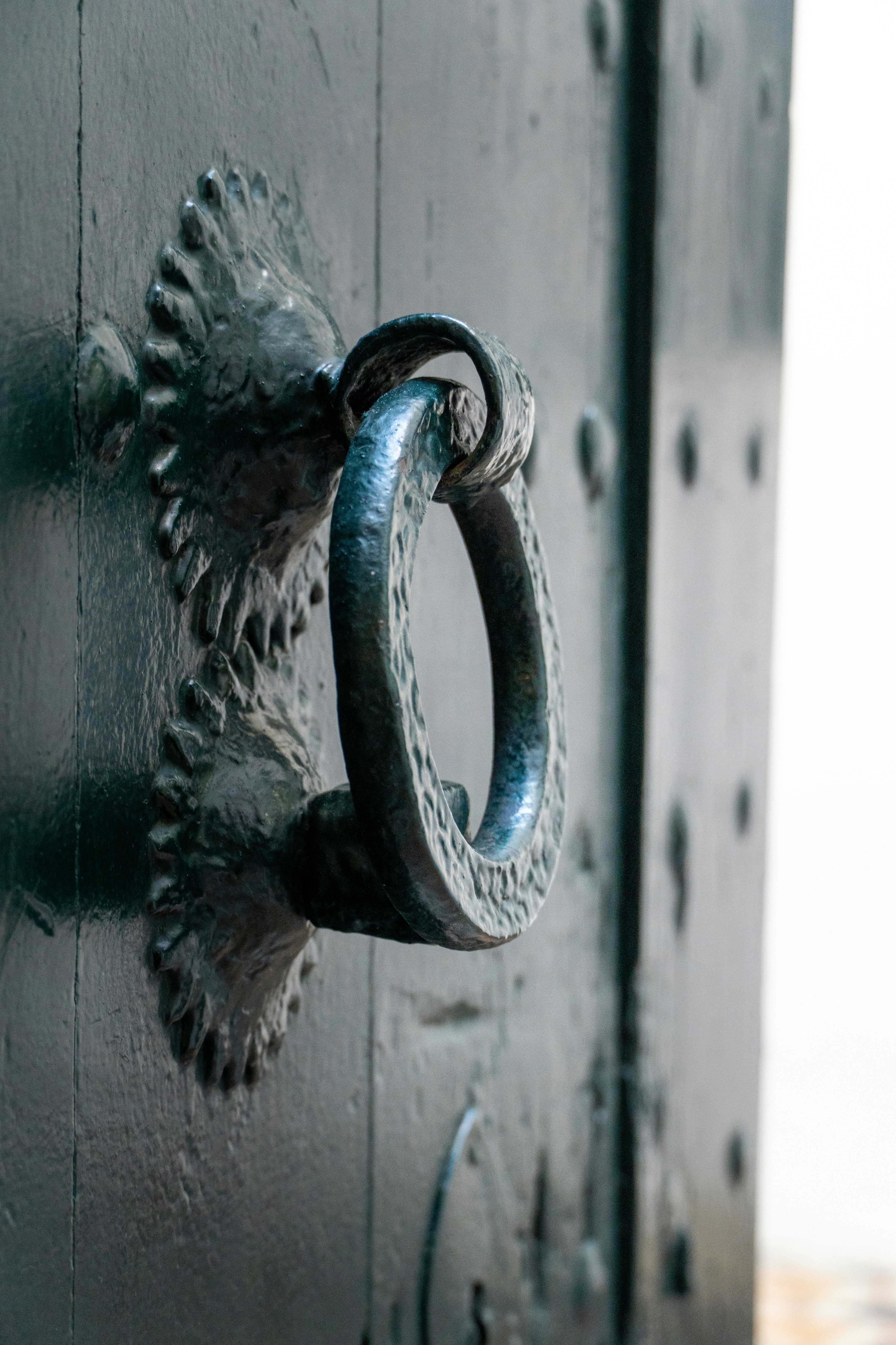 Iron Ring on a Weathered Door: A Close-Up of Craft and Age