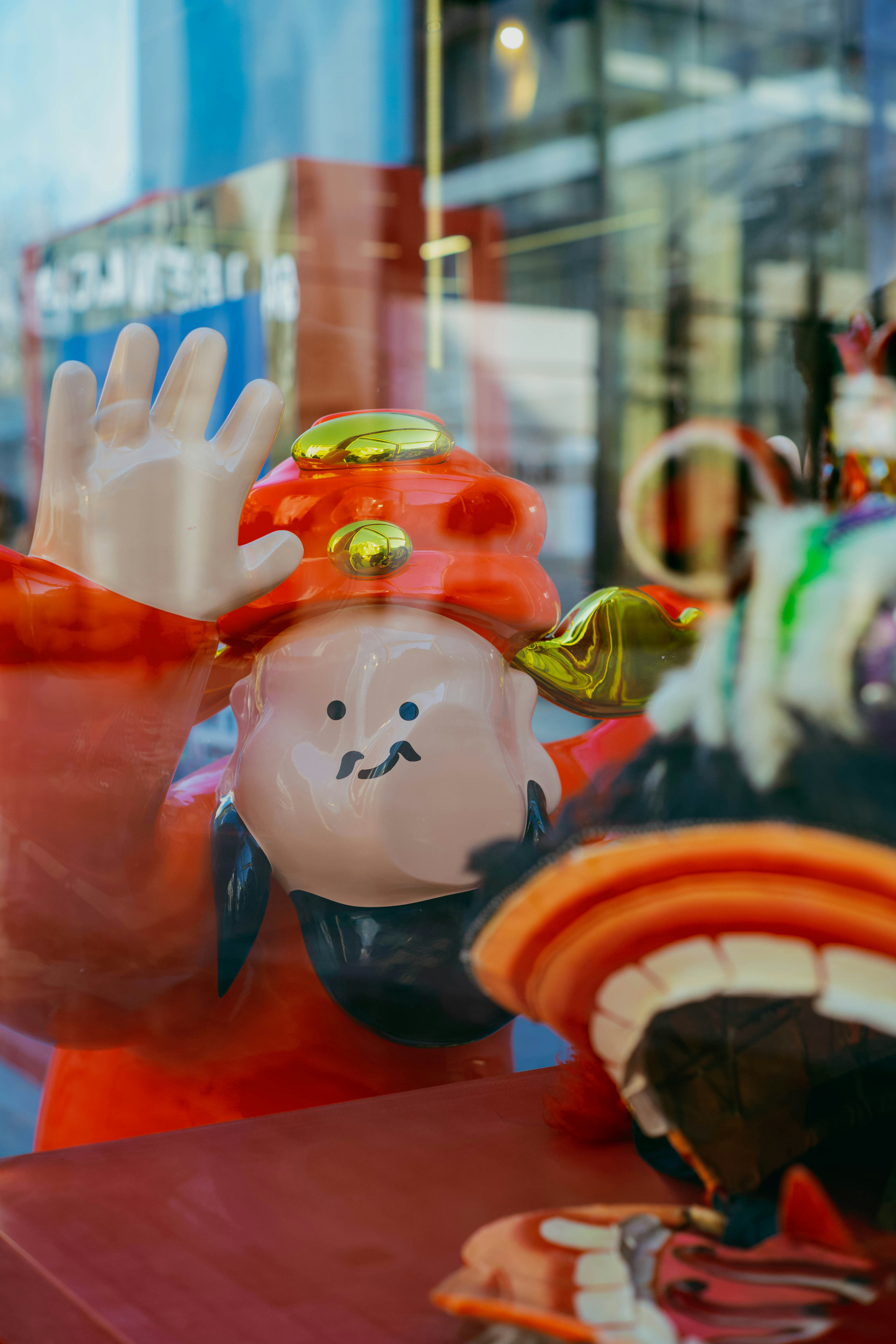 Smiling Toy Captain Waving Through a Shop Window