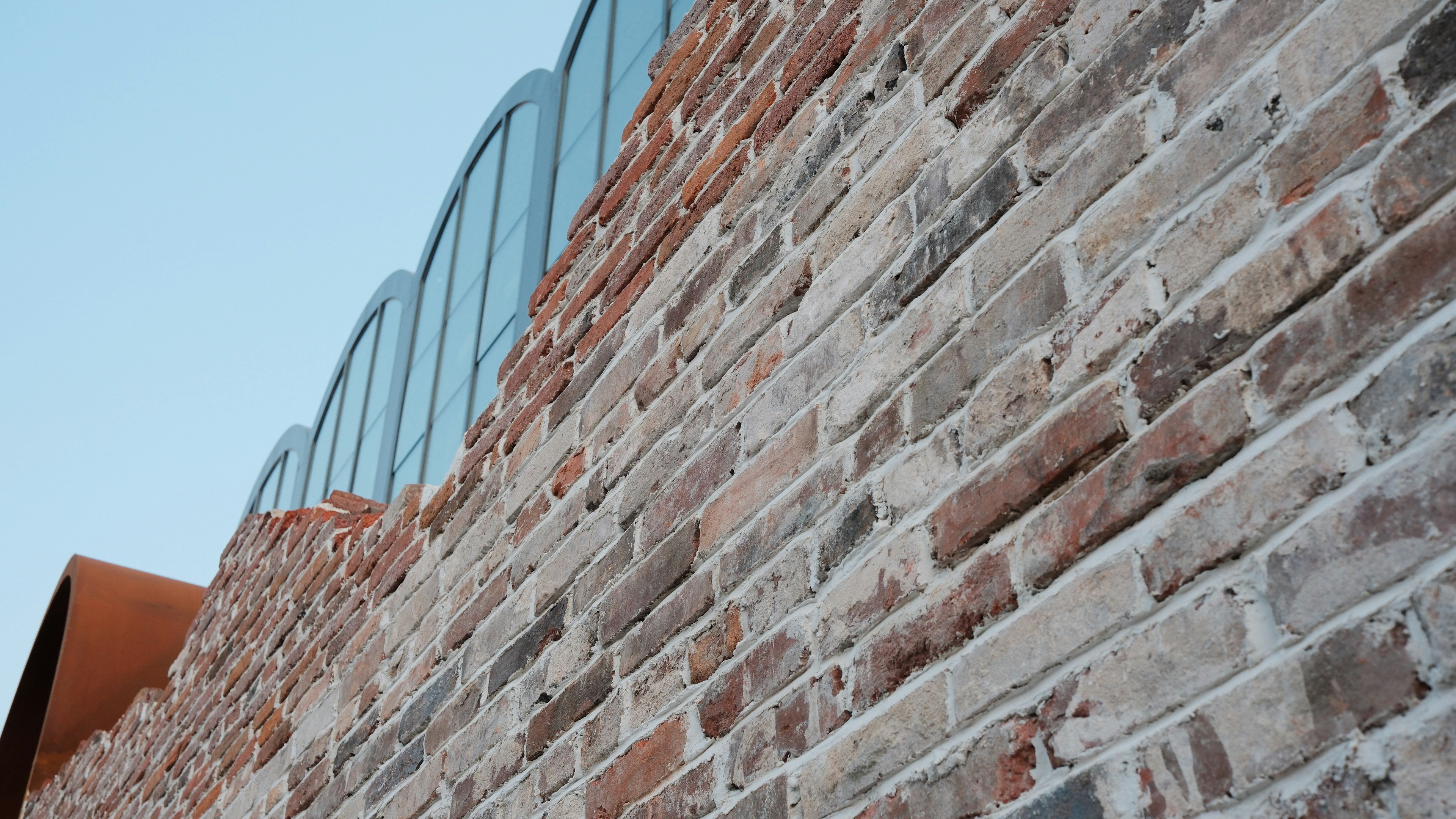 Brick Wall Overlook: A Rooftop Perspective Along a Gated Skyline