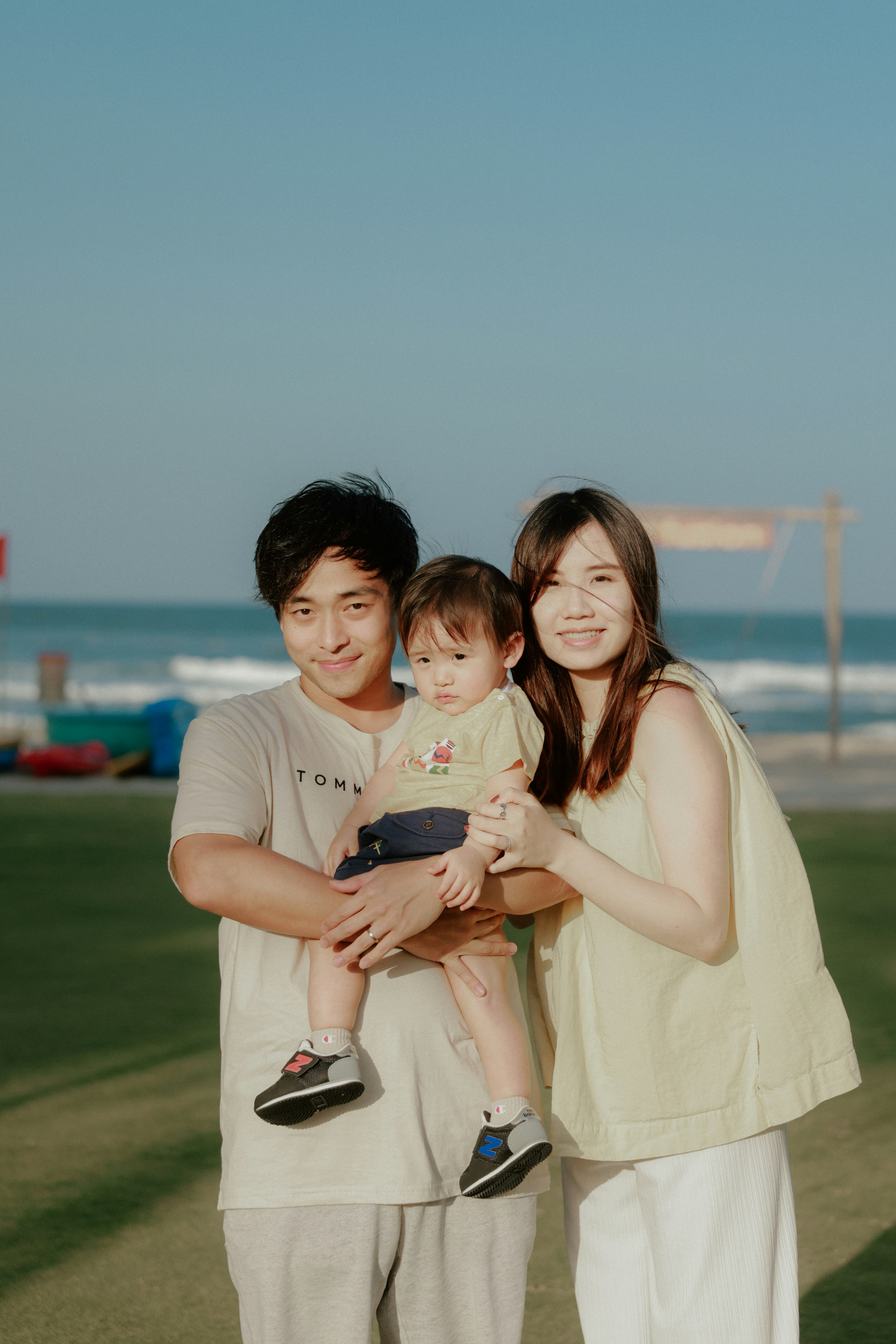 Family Portrait at the Ocean Shore Under Soft Evening Light