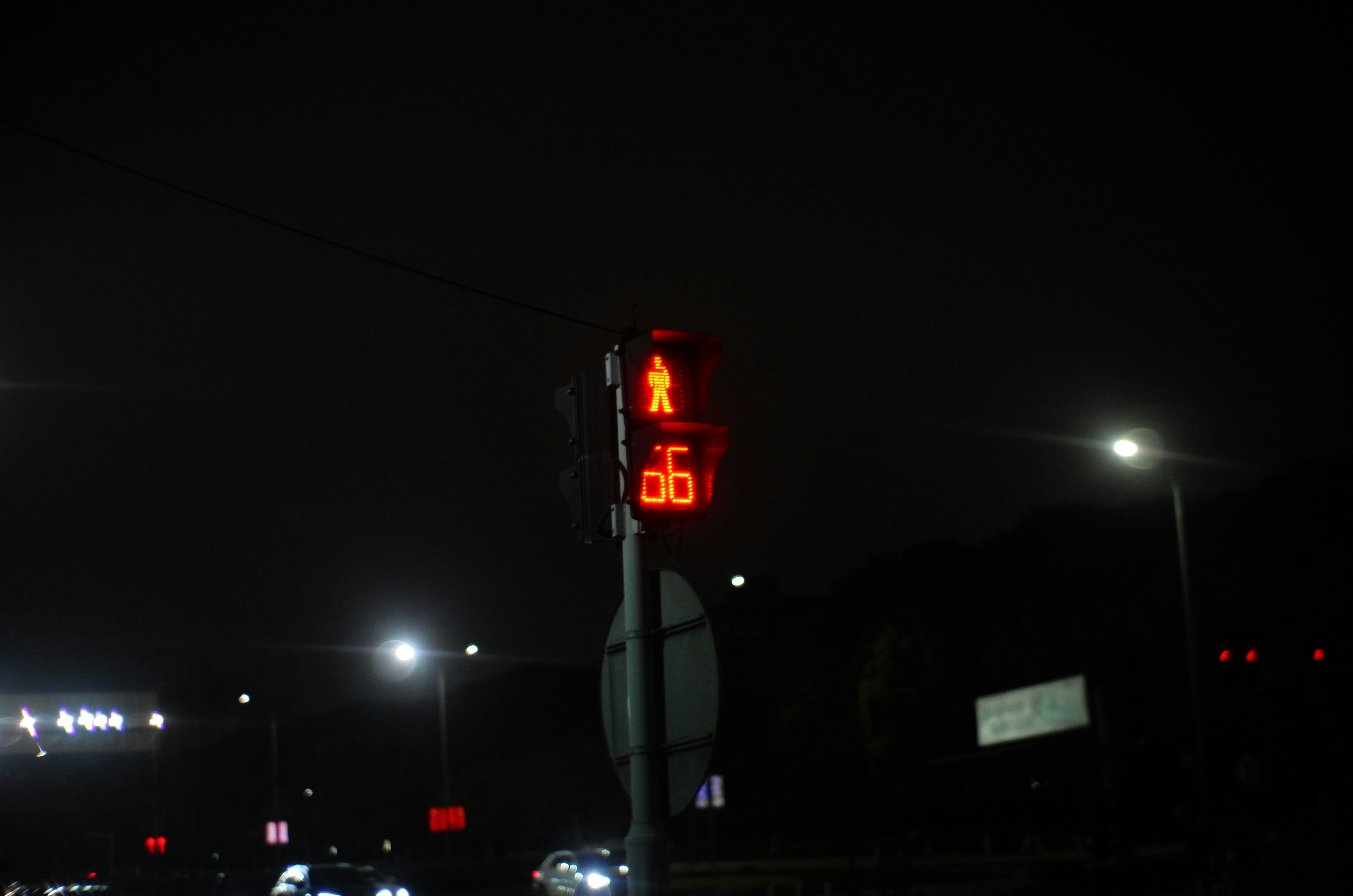 A red pedestrian crossing signal at night