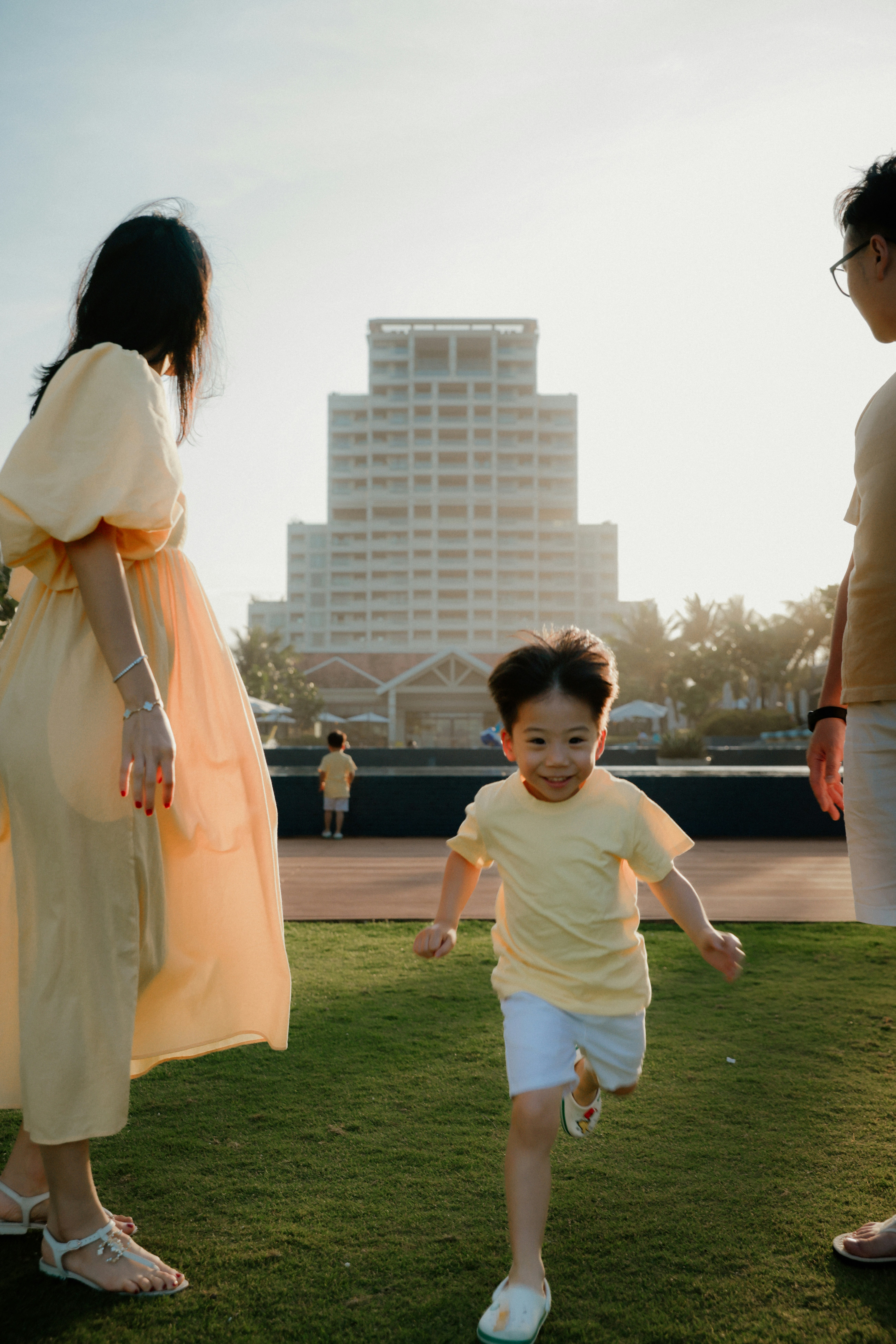 Sunny Playdate on the Lawn with a Towering Building Backdrop