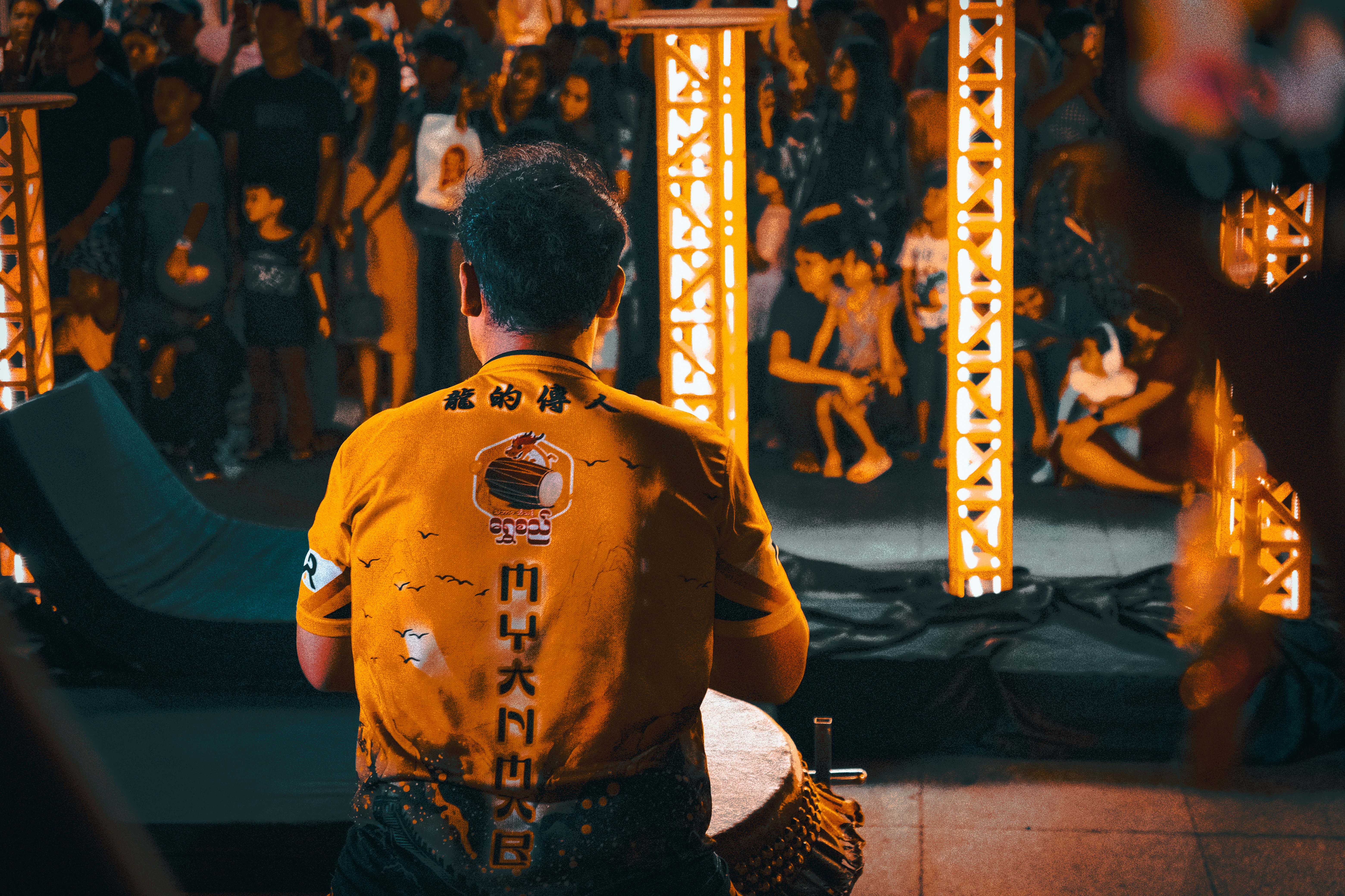 Backlit Drummer in a Golden Arena