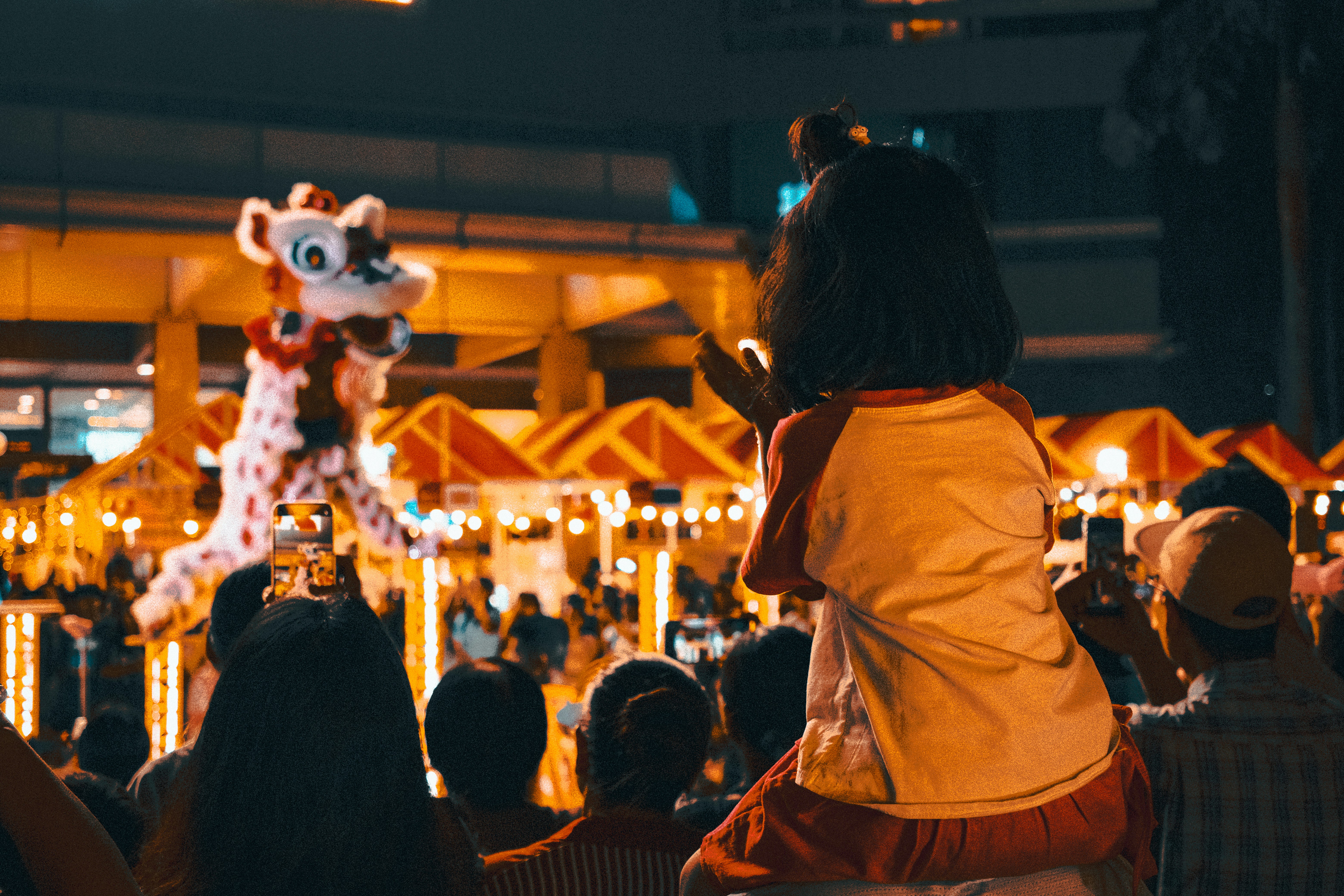 Audience on High: A child on shoulders framing a crowded festival stage