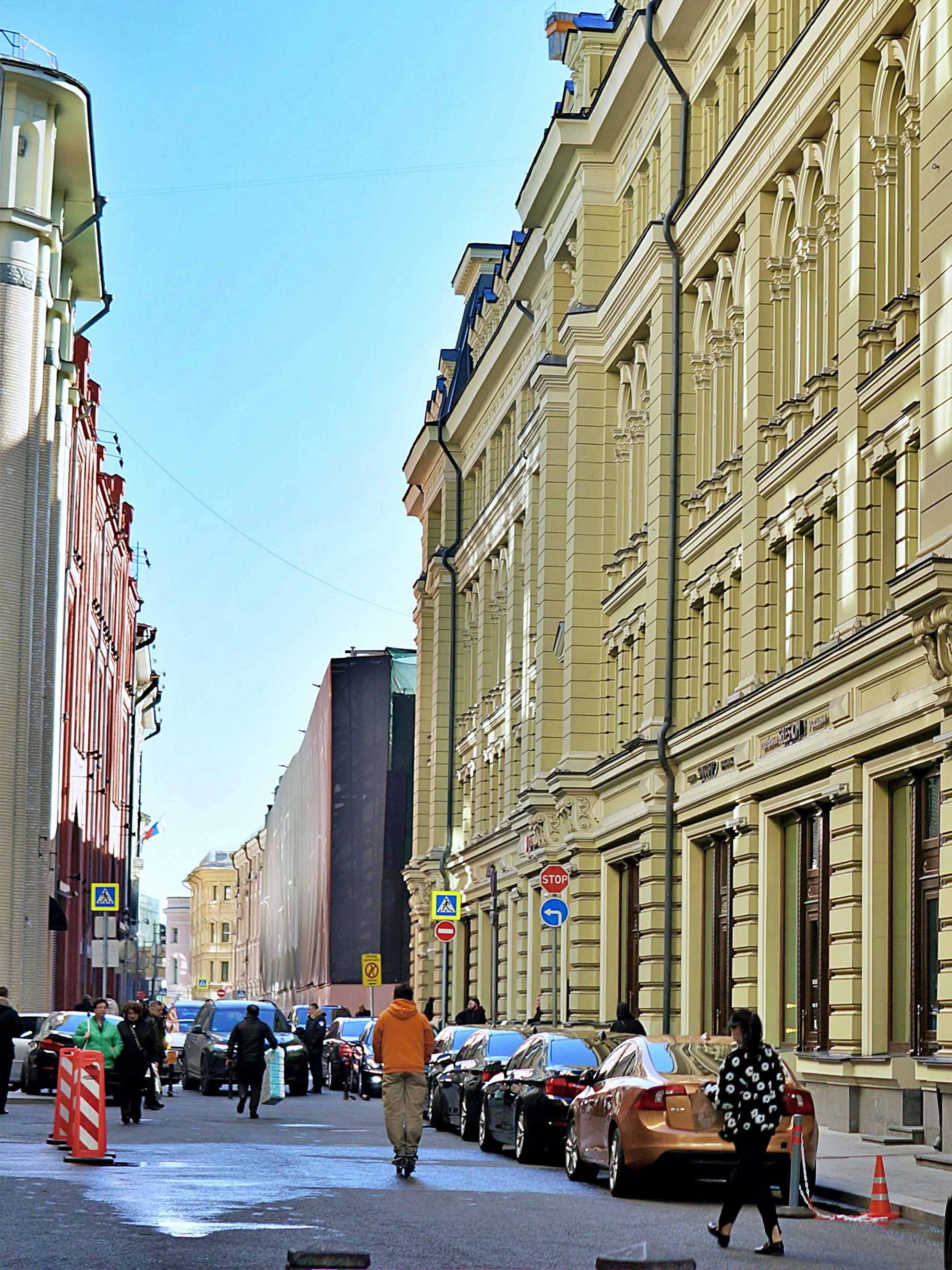 City Corridor of Yellow Facades and Moving Footpaths