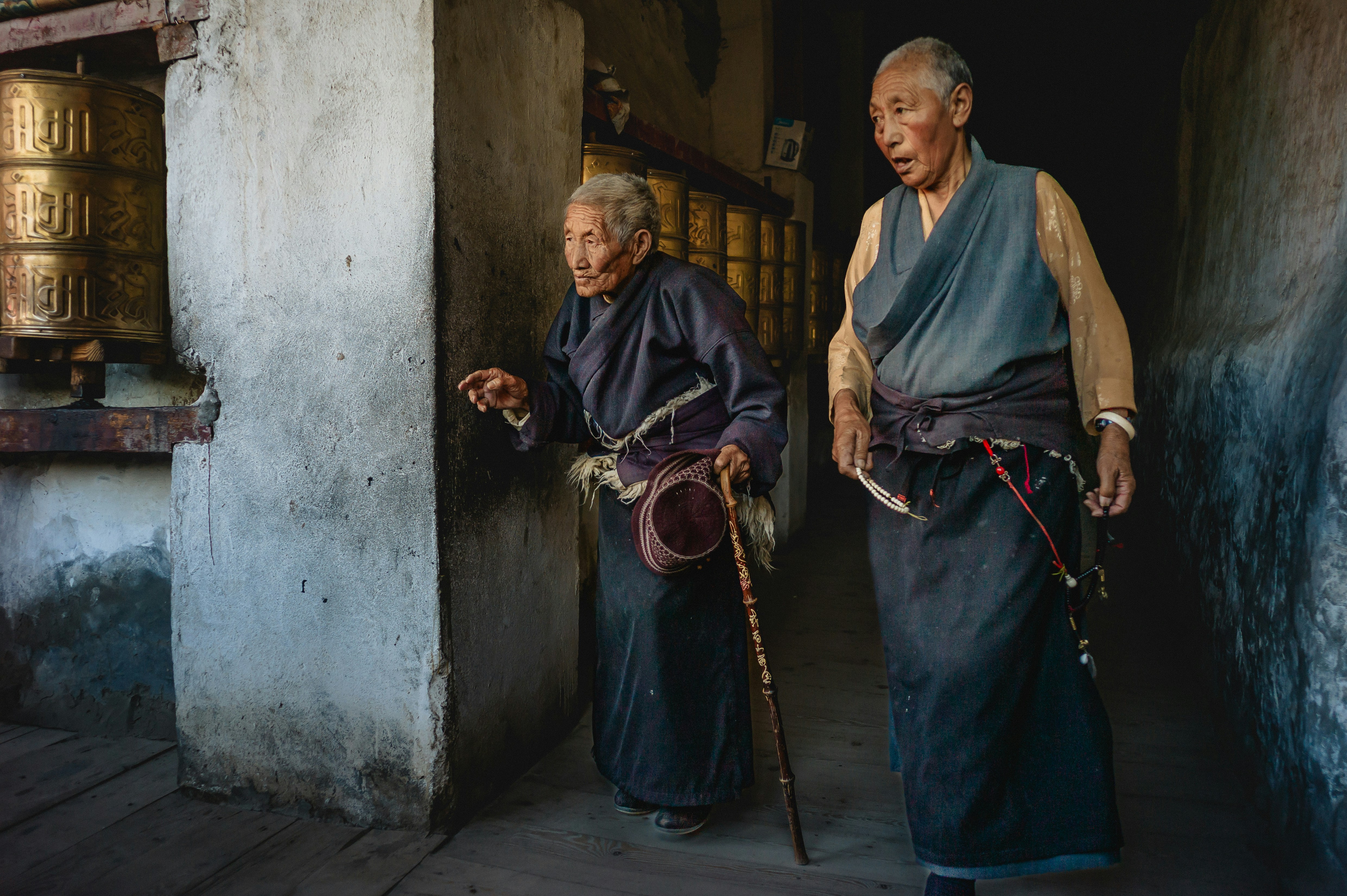 Two Elder Lamas at a Lanterned Threshold