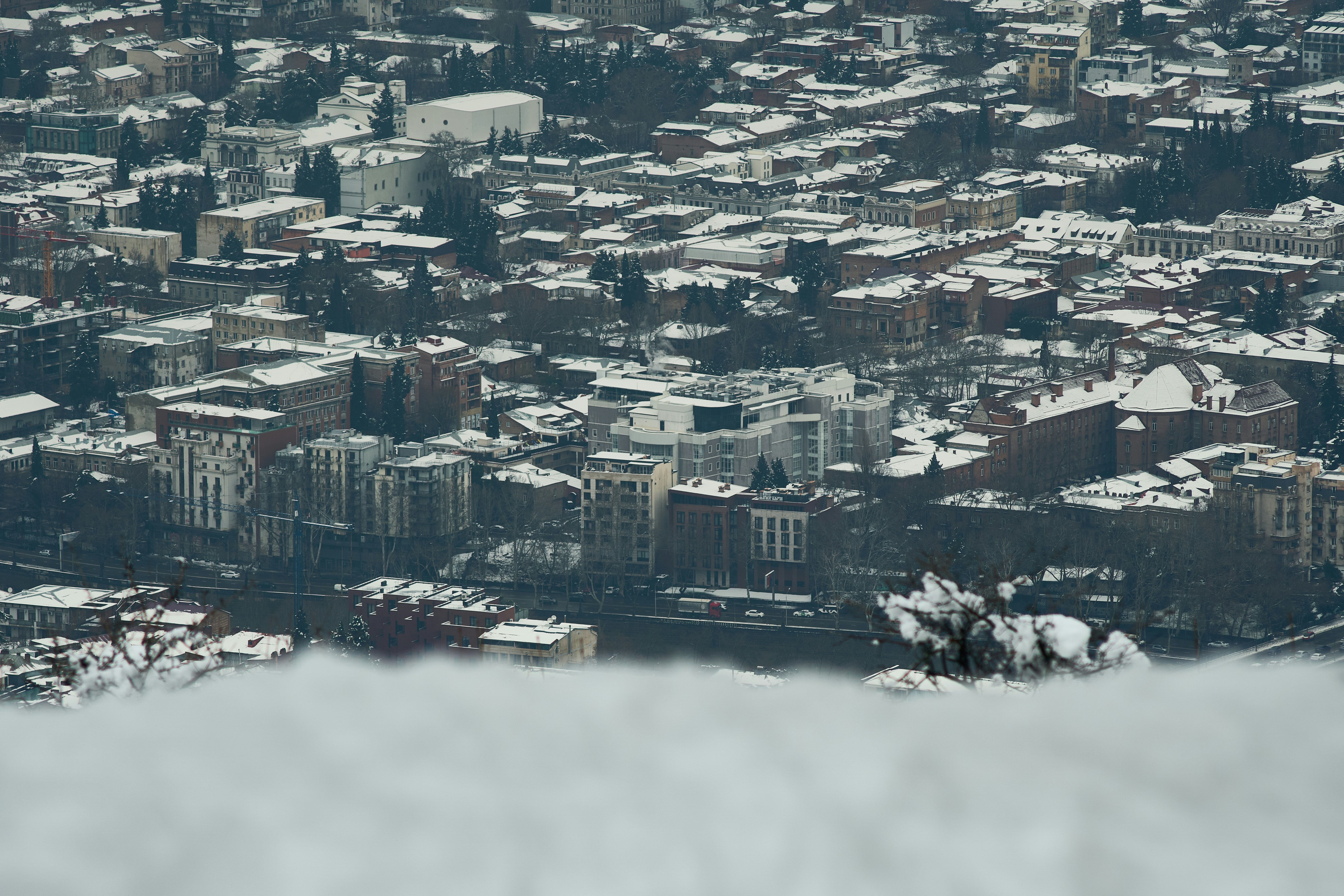 Snow-blanketed Cityscape from a Foggy Foreground