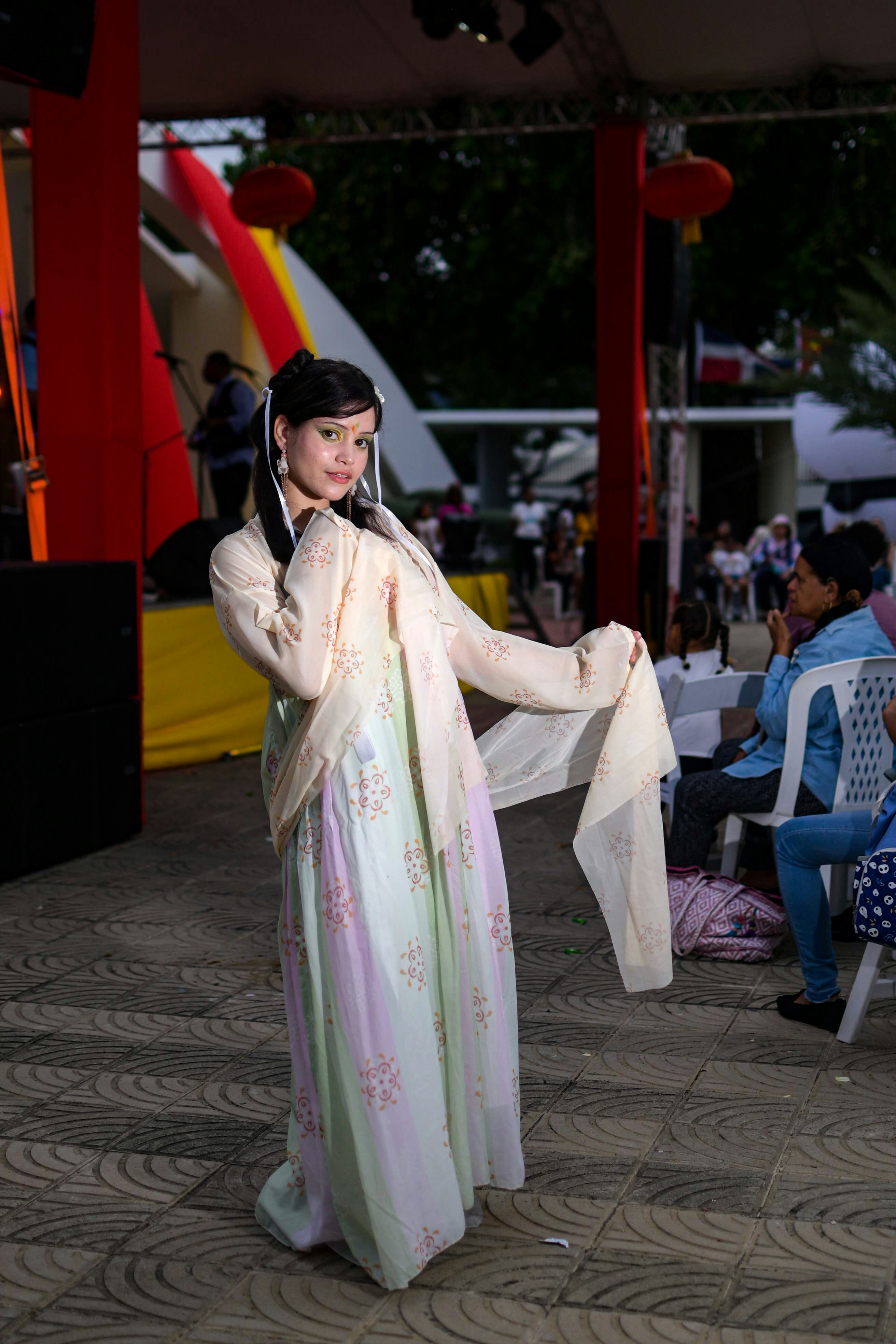 Grace in Silk: a poised portrait at a festive outdoor stage