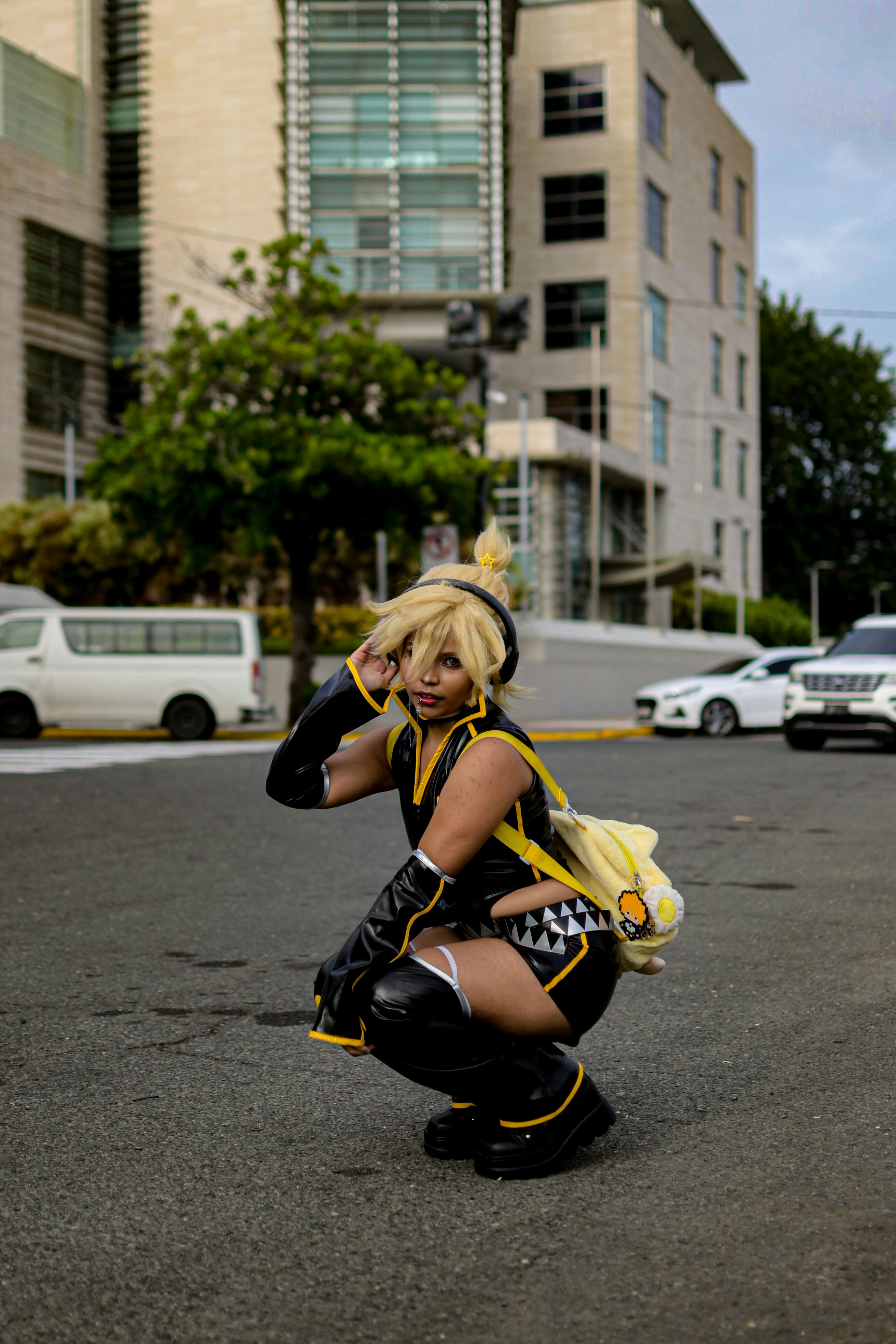 Urban Hero: Neon-Trimmed Cosplay Crouch in the Street