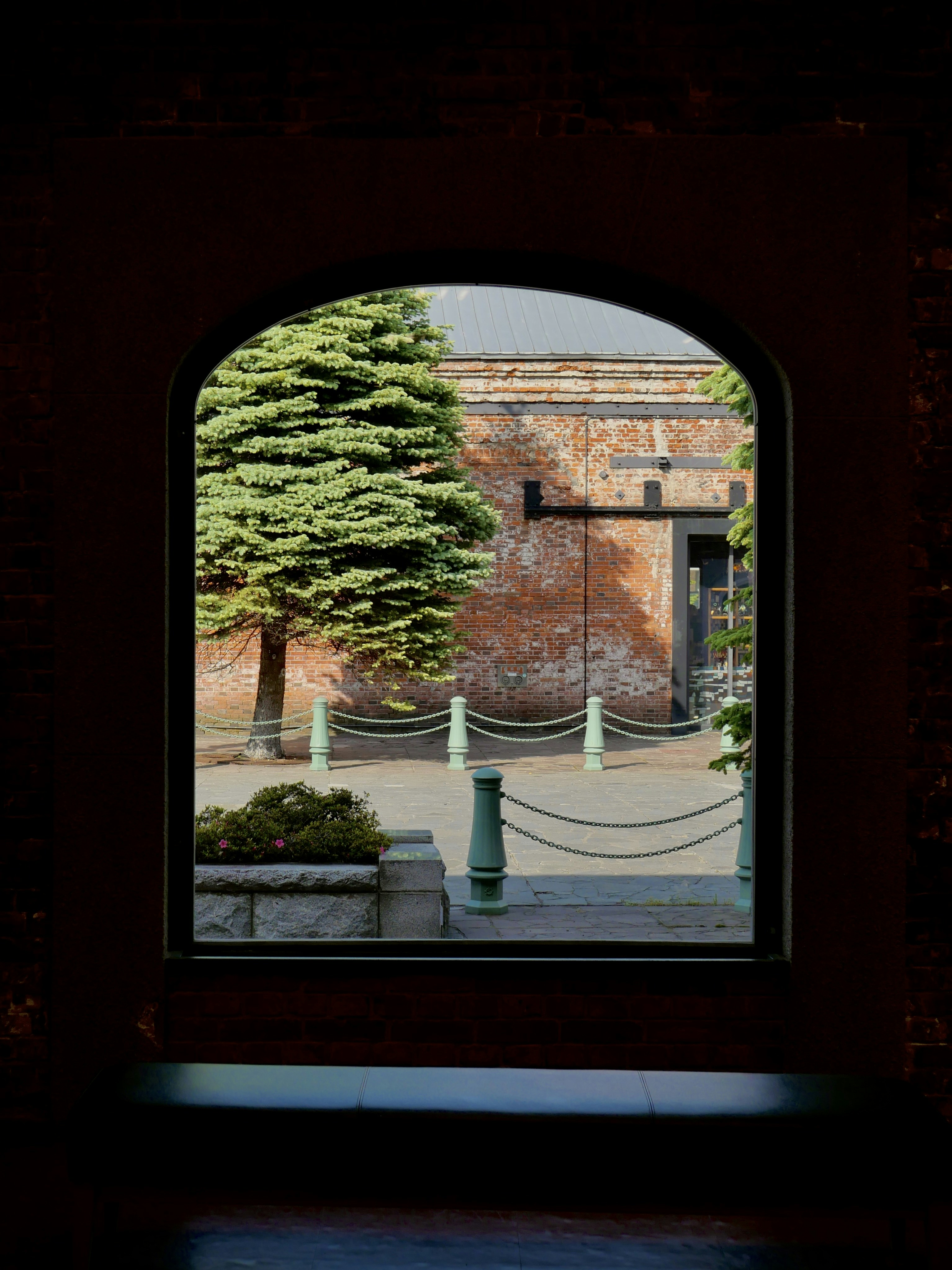 A Quiet Archway Framing a Brick Courtyard