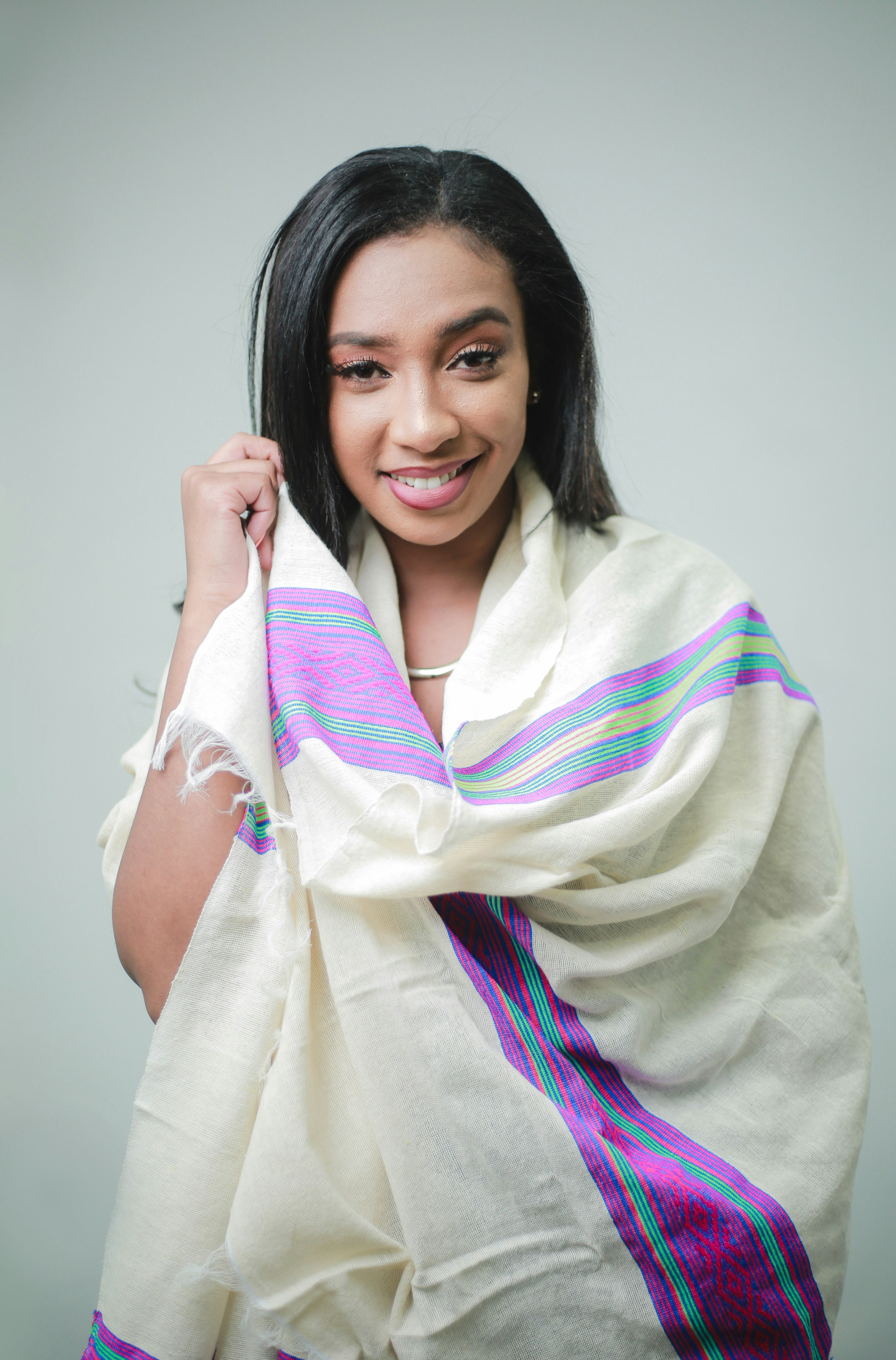 Graceful Gaze: Portrait Wrapped in Cream and Colorful Stripes