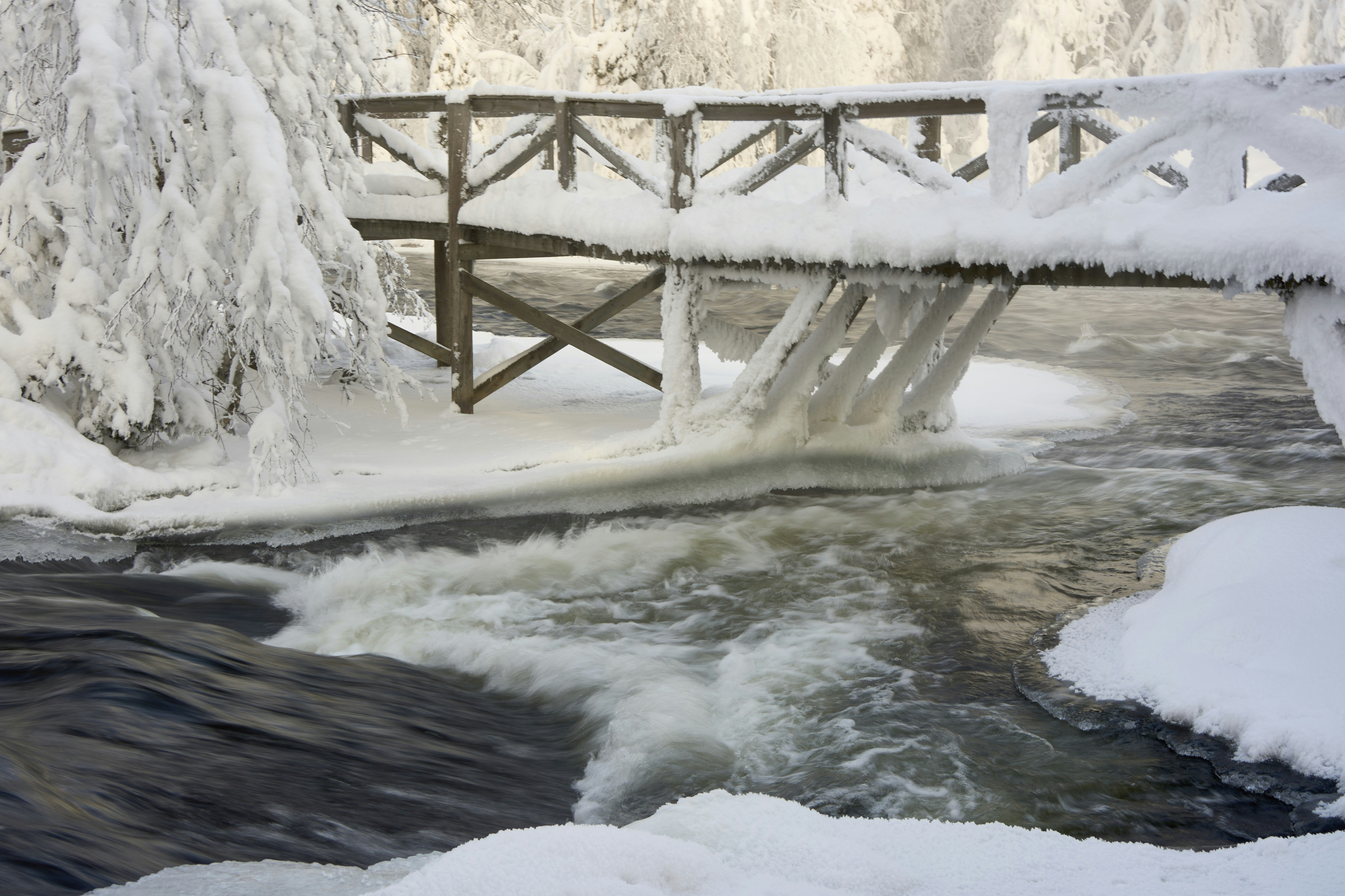 Snowbound Bridge over a Freezing Current