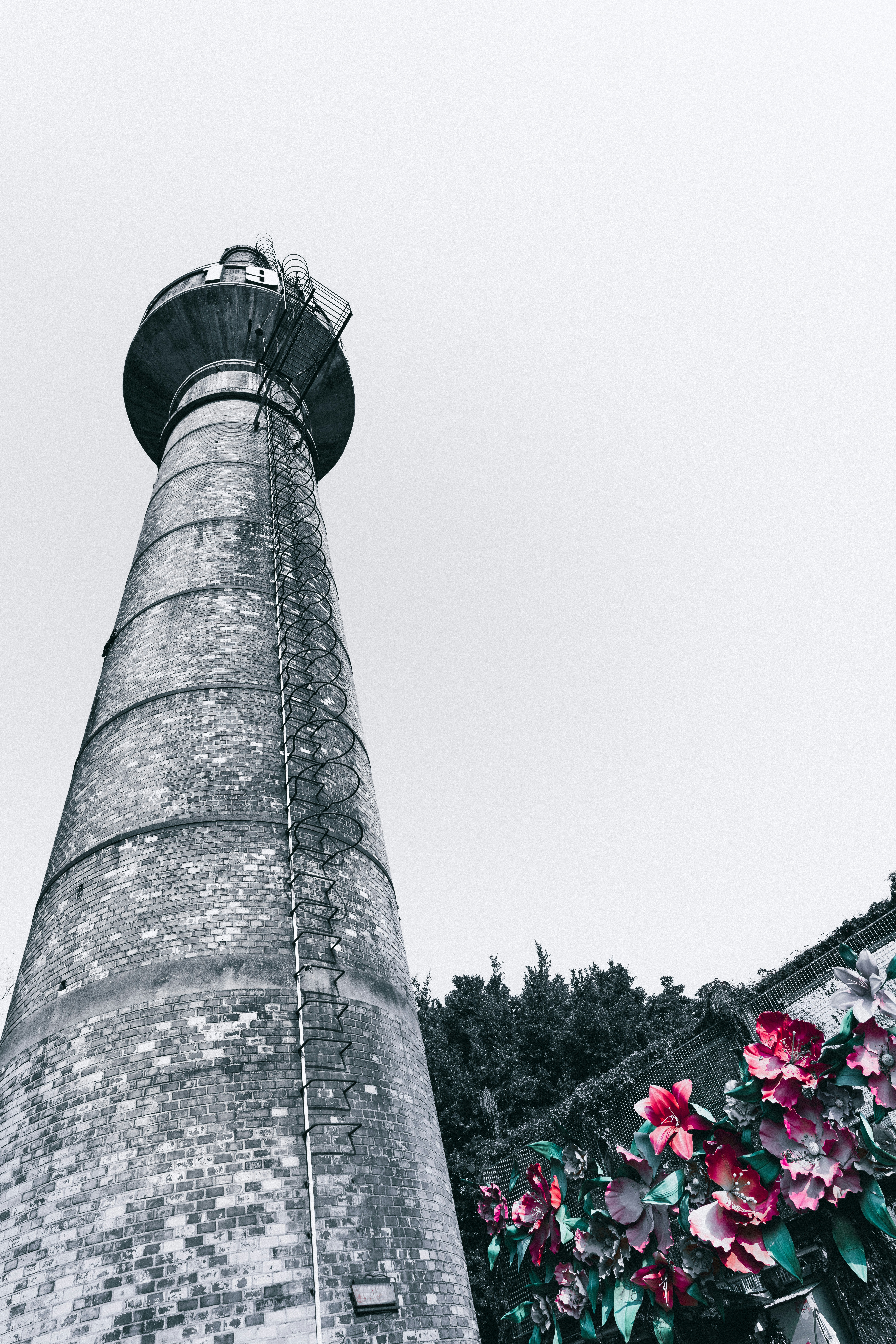 Brick Tower Ascending: A Lighthouse Exhale into Overcast Skies