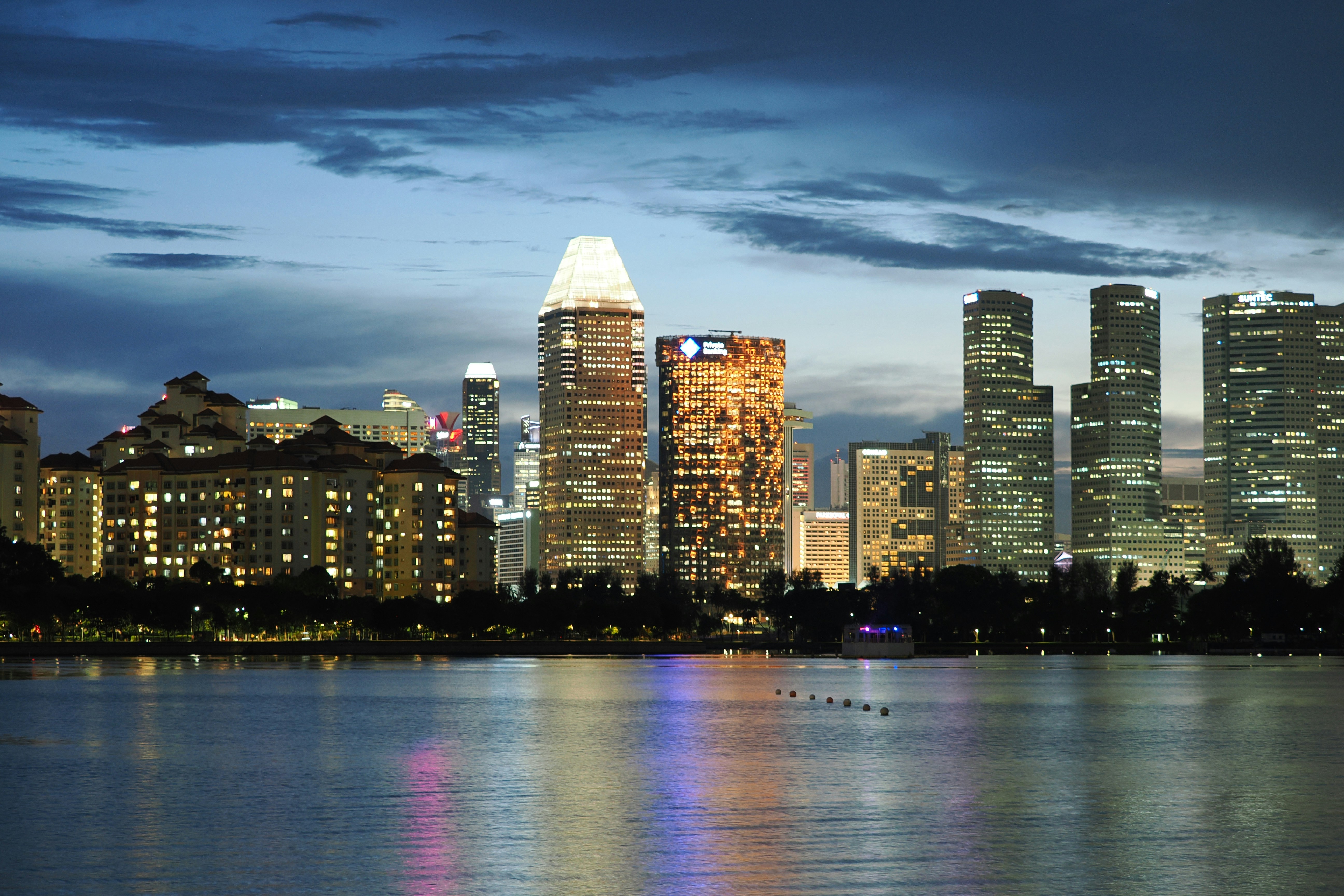 Twin-Tower Waterfront Glow Over Calm Harbor